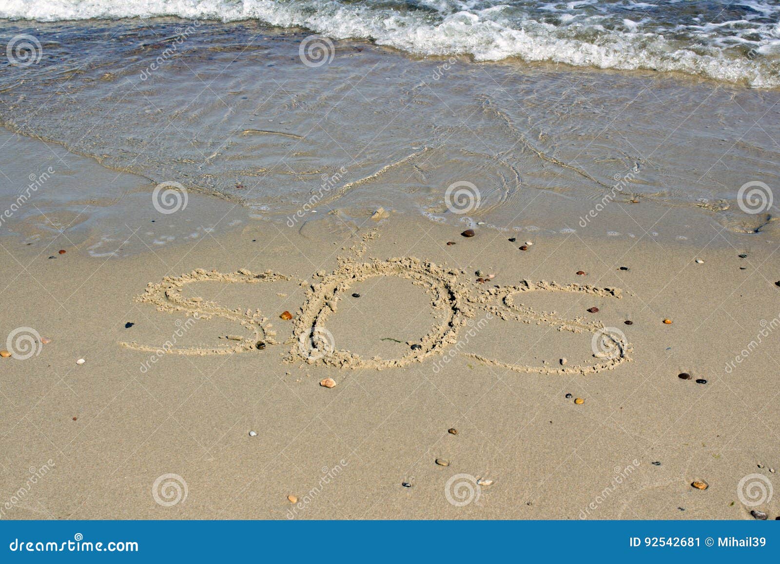 SOS - Word Drawn on the Sand Beach with the Soft Wave. Stock Image ...