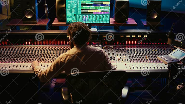 Sound Designer Mixing and Mastering Tracks on Audio Console in Control ...