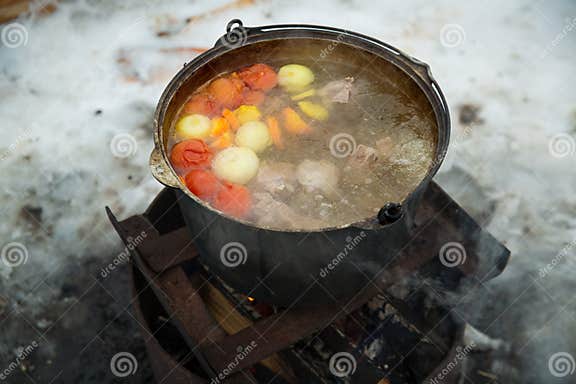 The Soup is Cooked in a Large Pot Over a Fire. Stock Photo - Image of ...