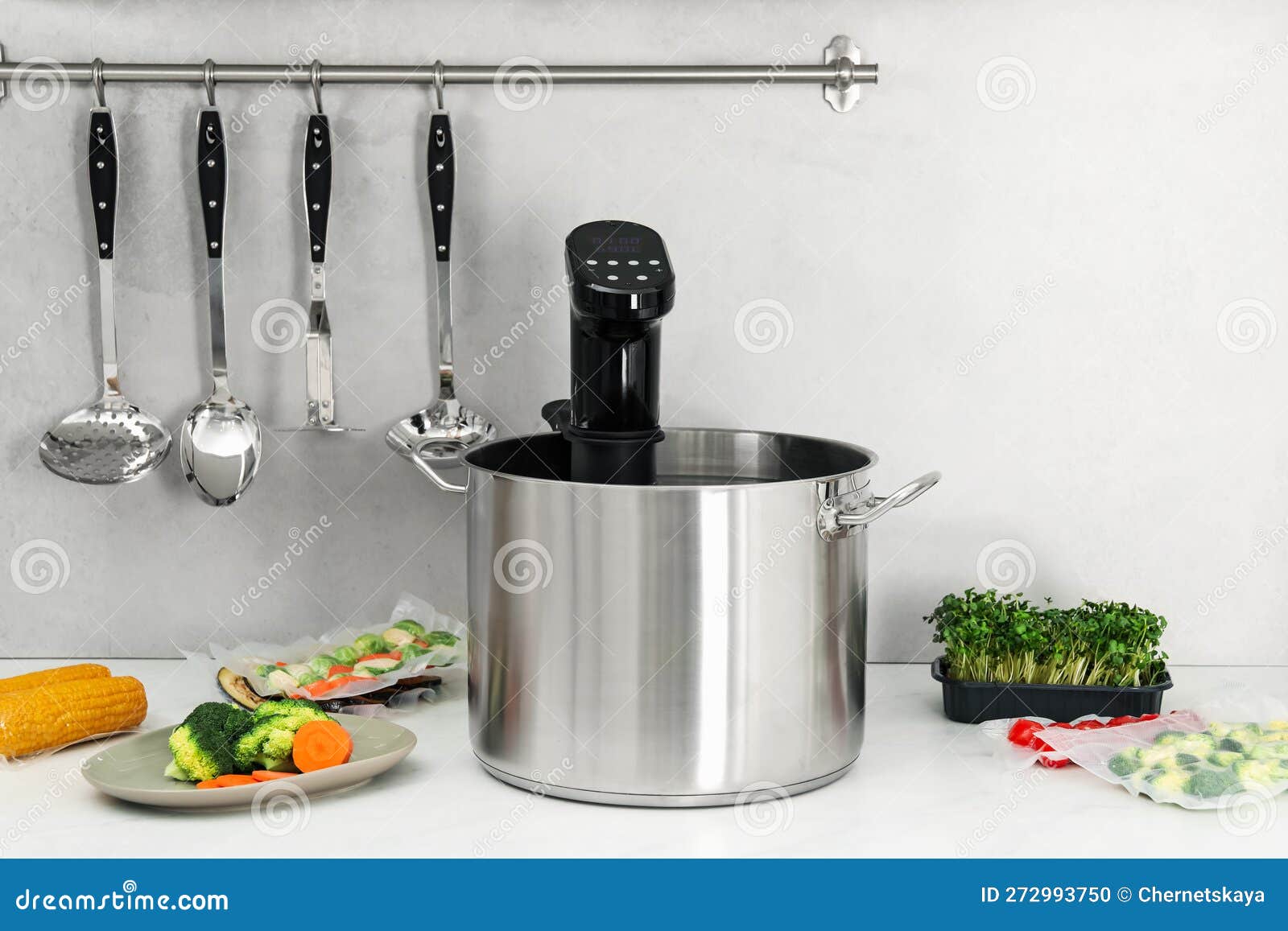 Sous Vide Cooker in Pot and Ingredients on White Table. Thermal ...