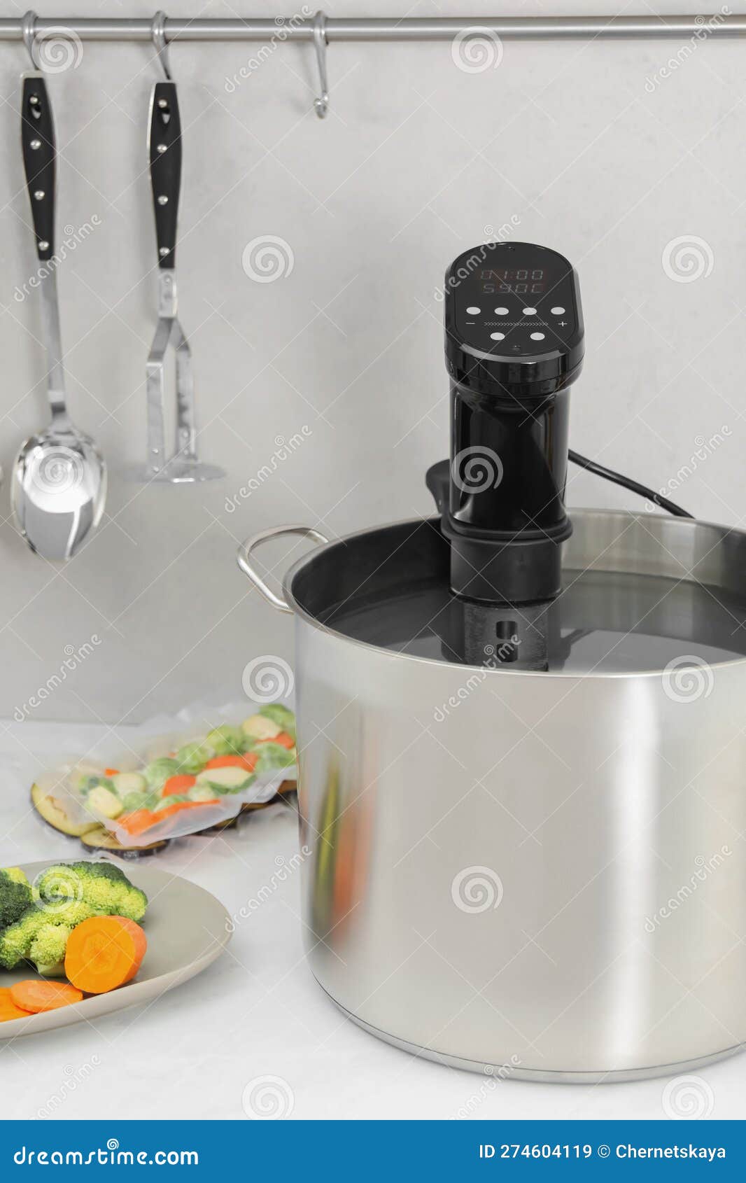 Sous Vide Cooker in Pot and Ingredients on White Table. Thermal ...