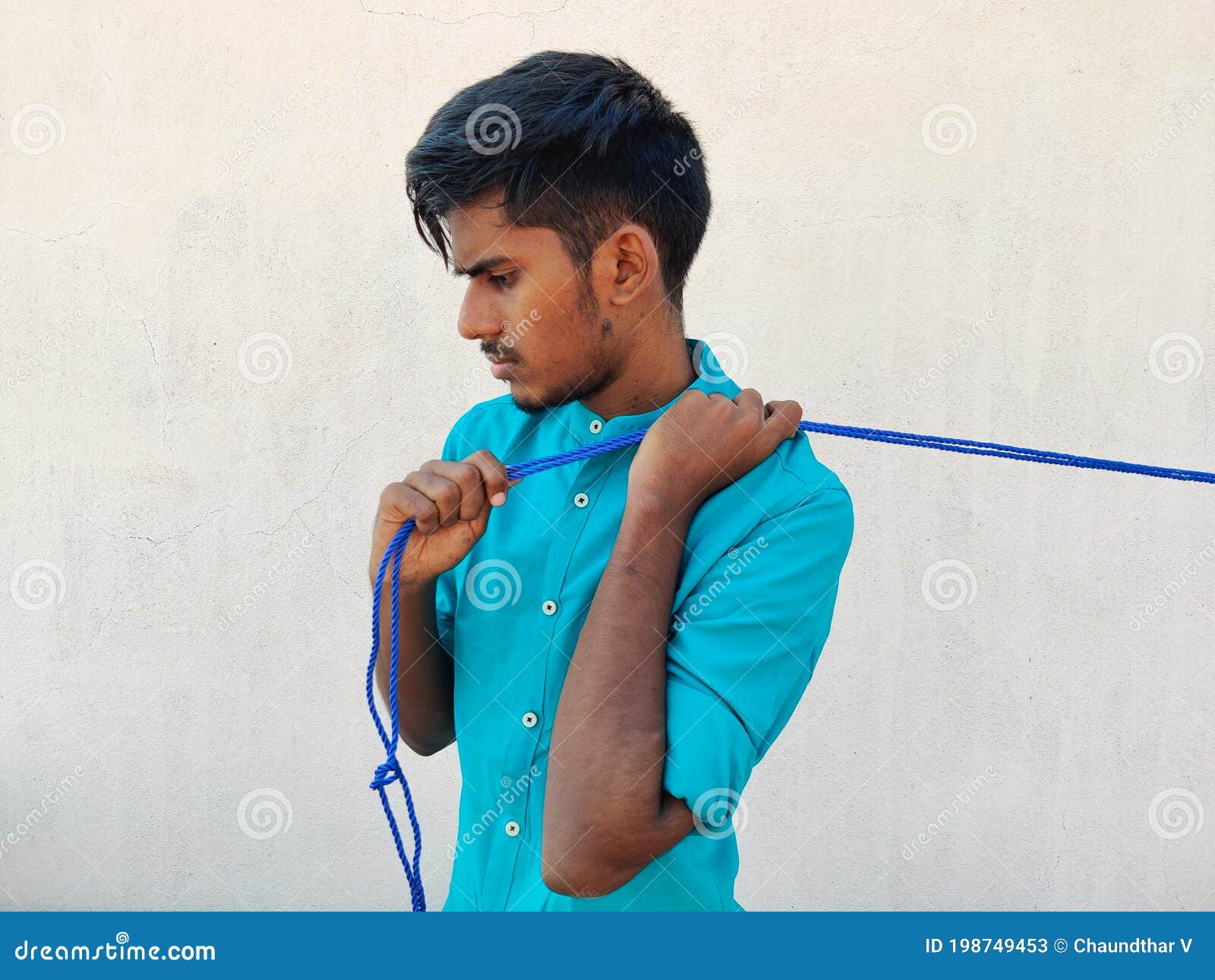 South Indian Young Man Pulling A Blue Color Rope Royalty-Free Stock ...