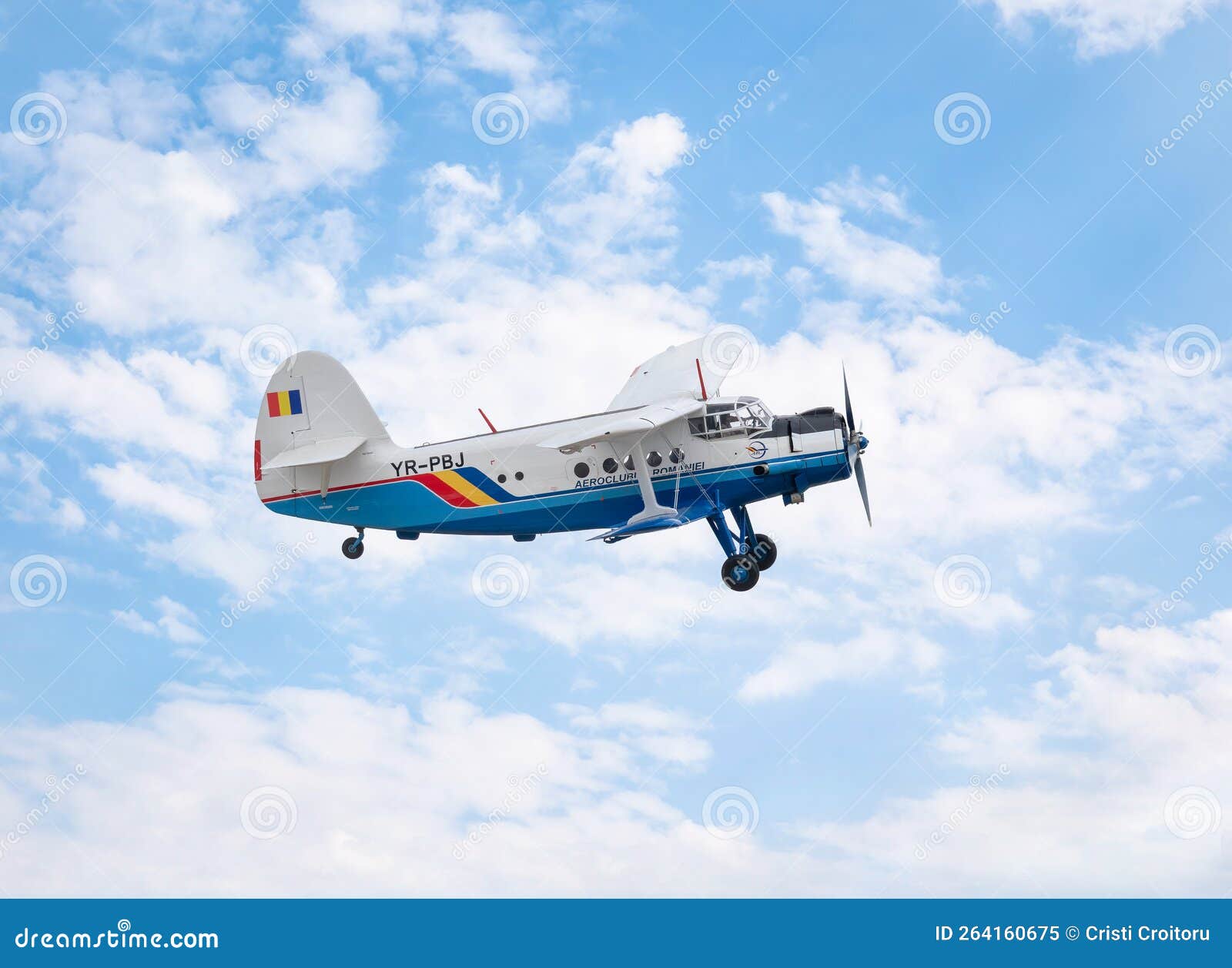 A Soviet Antonov an-2 Single-engine Biplane Flying Against Blue Sky ...