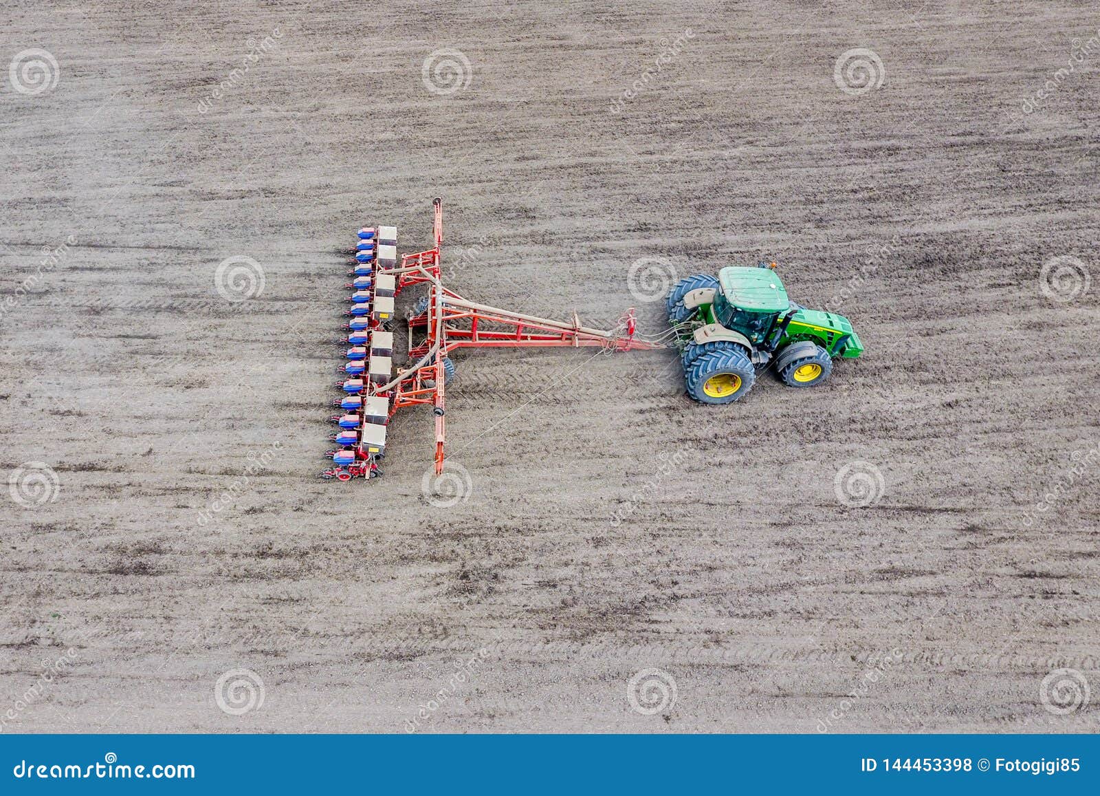 Sowing Of Corn. Tractor With A Seeder On The Field. Using A Seeder For ...