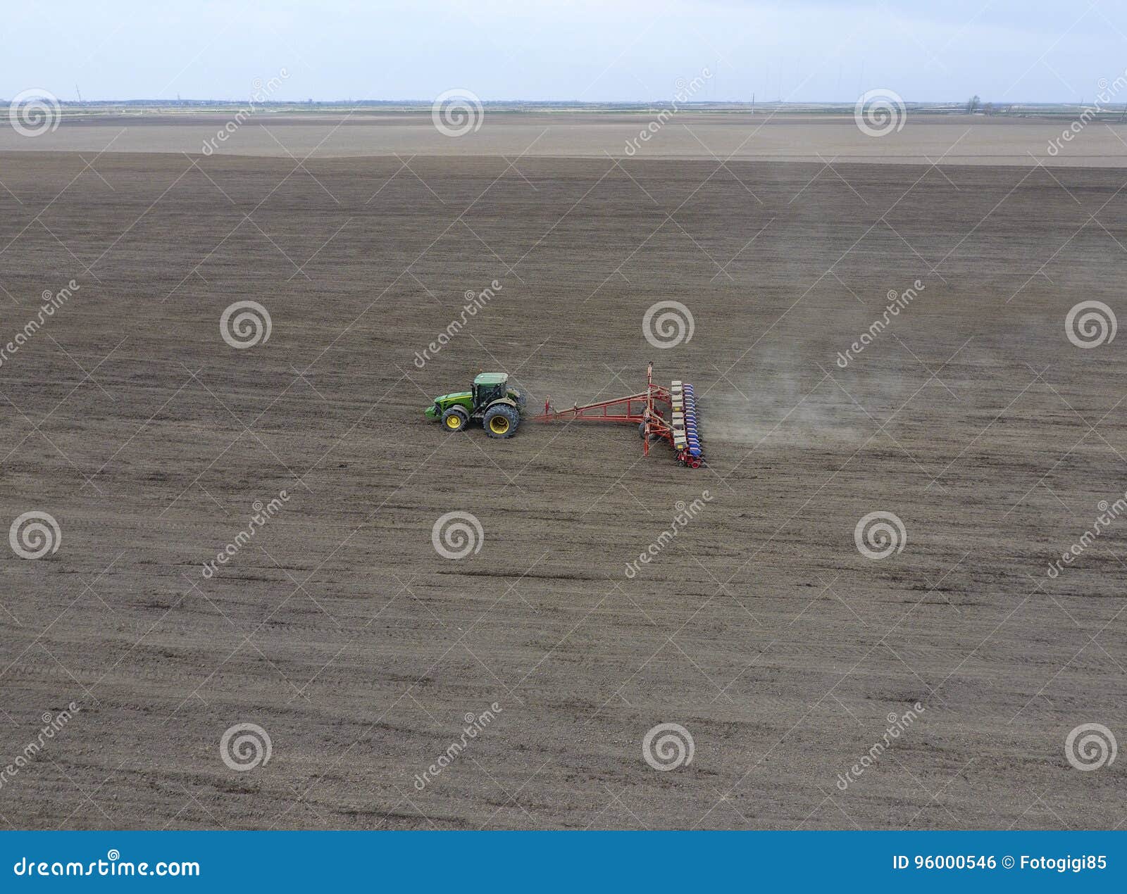 Sowing Of Corn. Tractor With A Seeder On The Field. Using A Seeder For ...