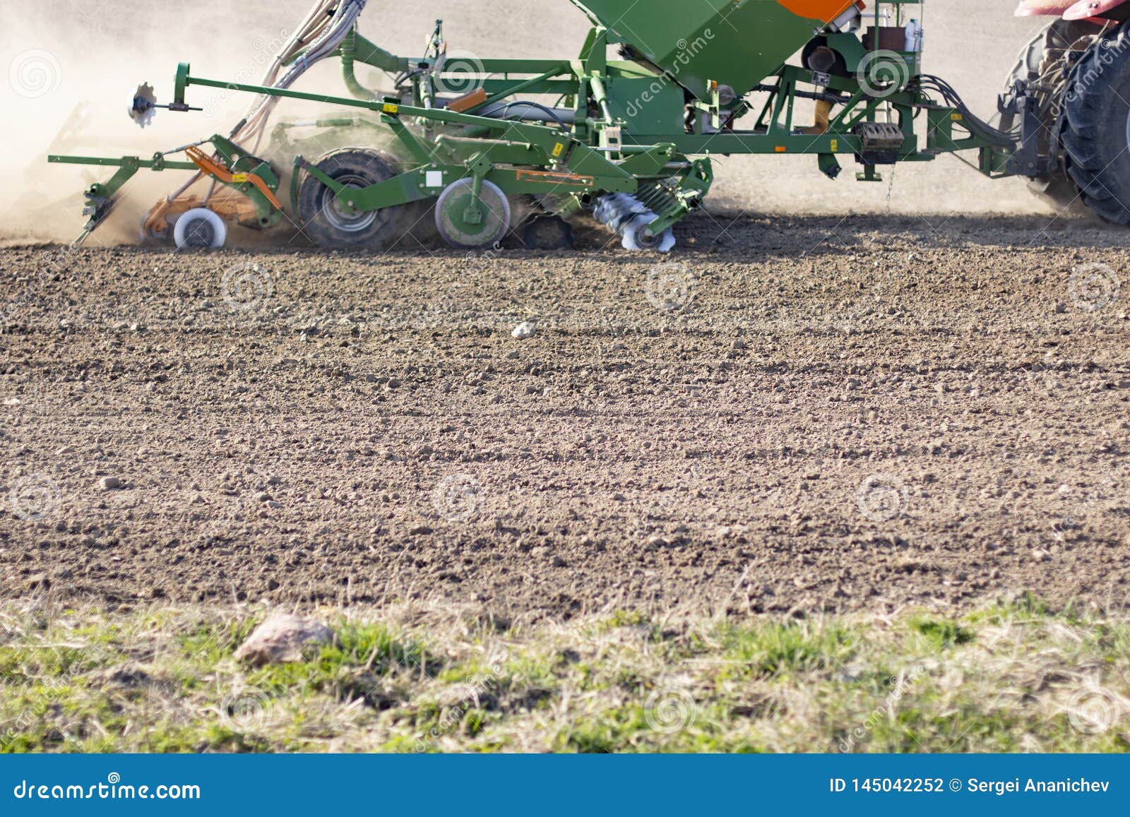 Sowing Time.tractor Trailer Rides on the Field and Sows Grain Stock ...