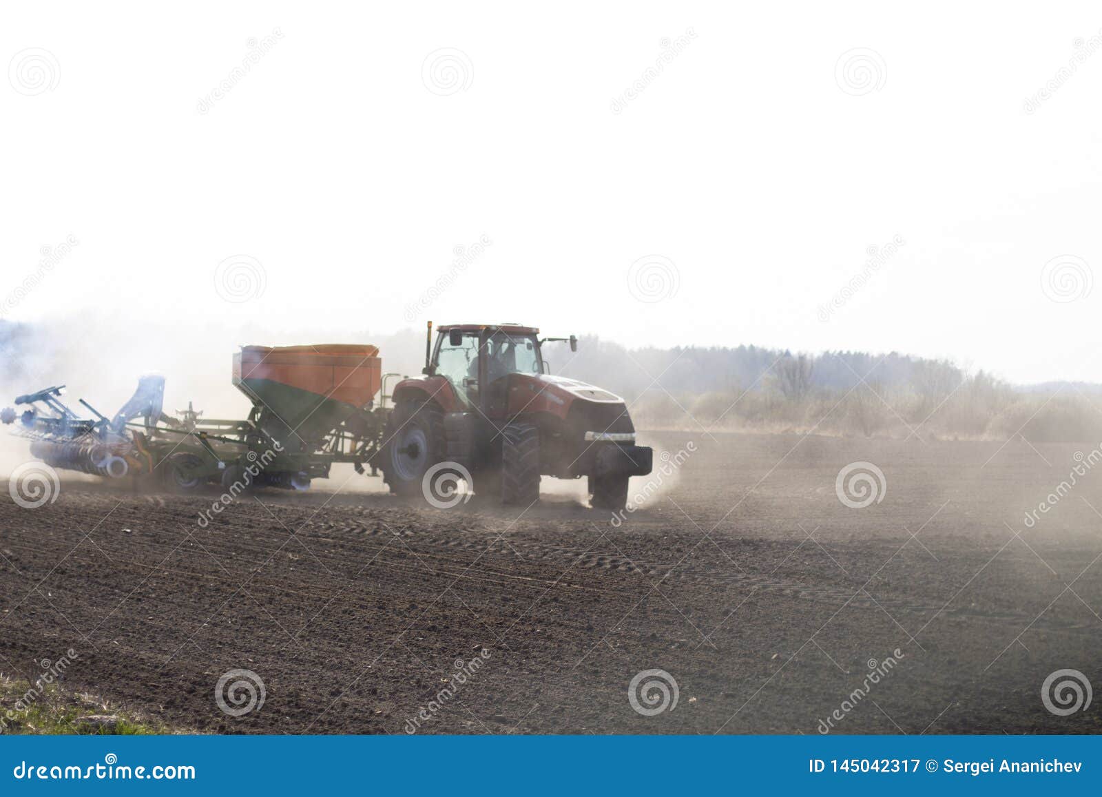 Sowing Time.tractor Trailer Rides on the Field and Sows Grain Stock ...