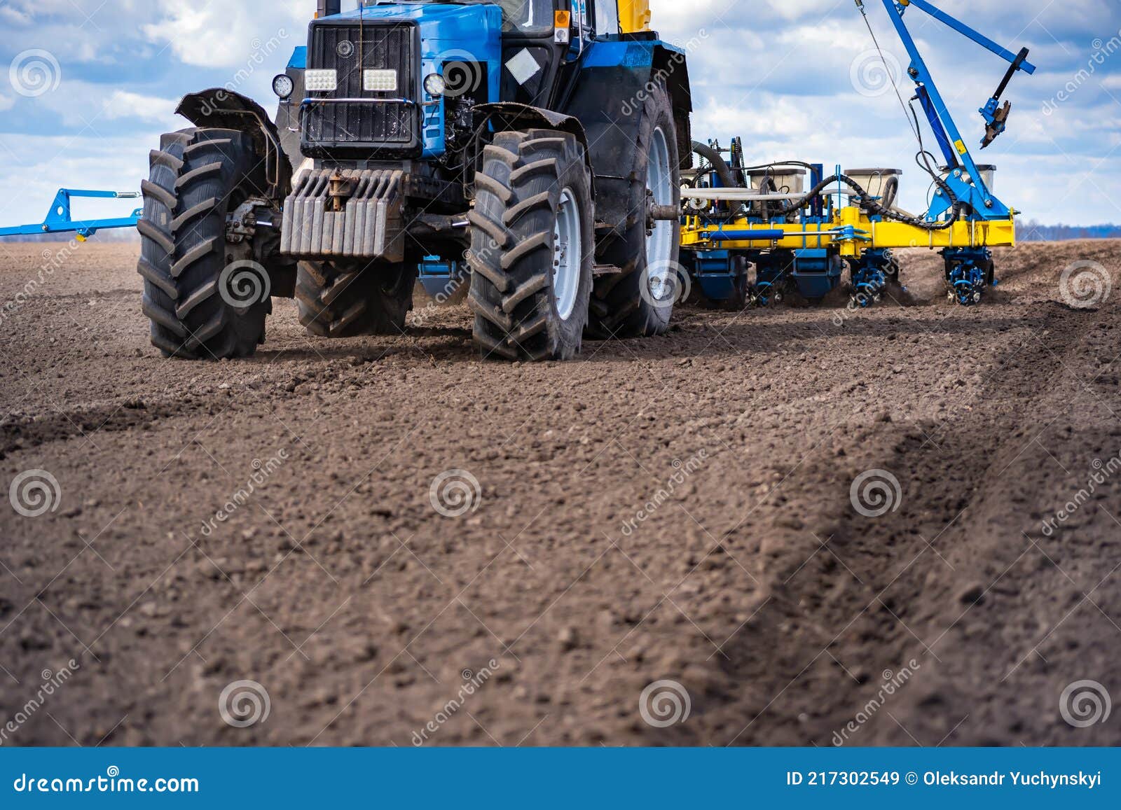 Sowing Work in the Field in Spring. Tractor with Seeder Stock Image ...