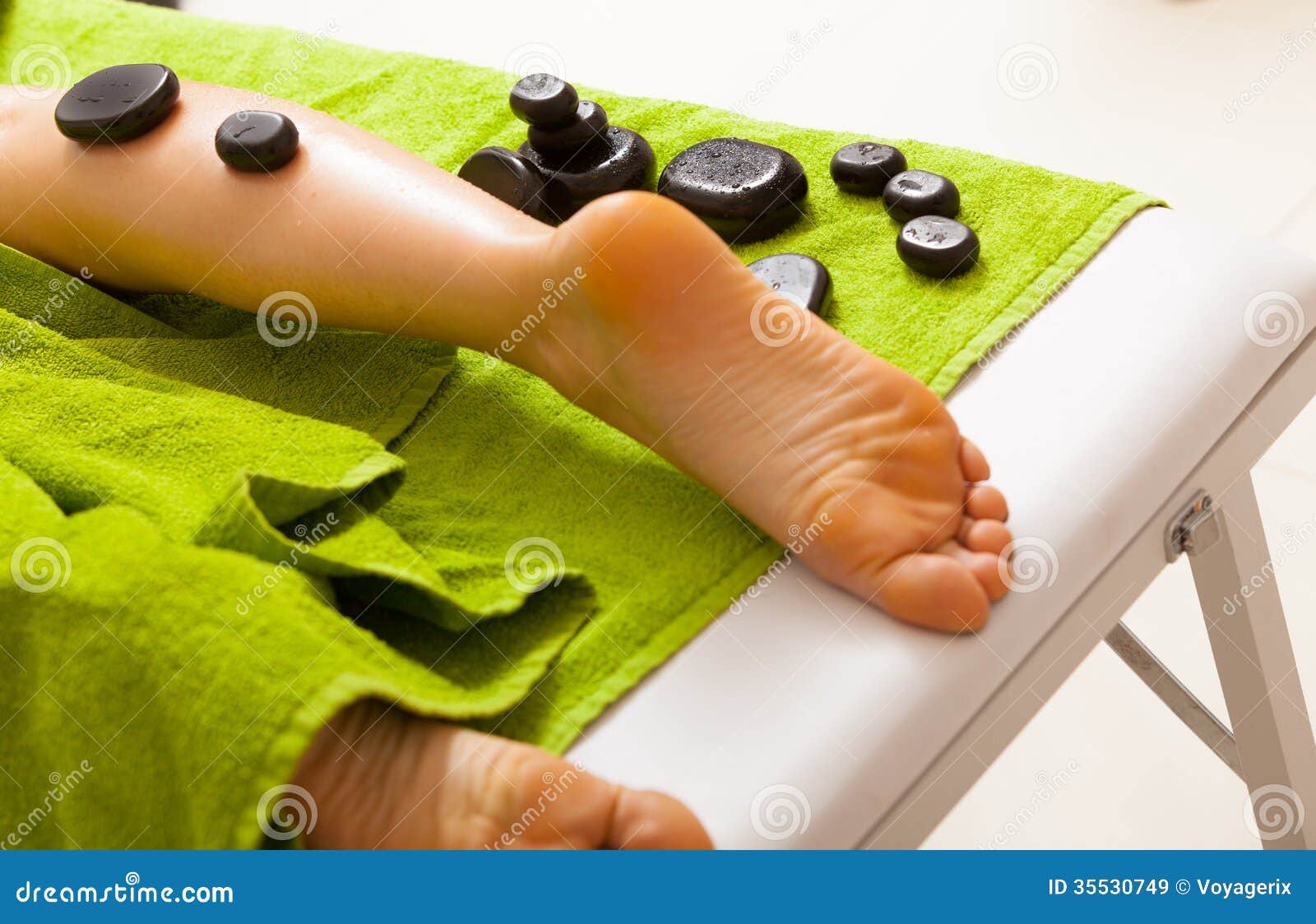 Spa Salon Female Legs Having Hot Stone Massage Bodycare And Relax
