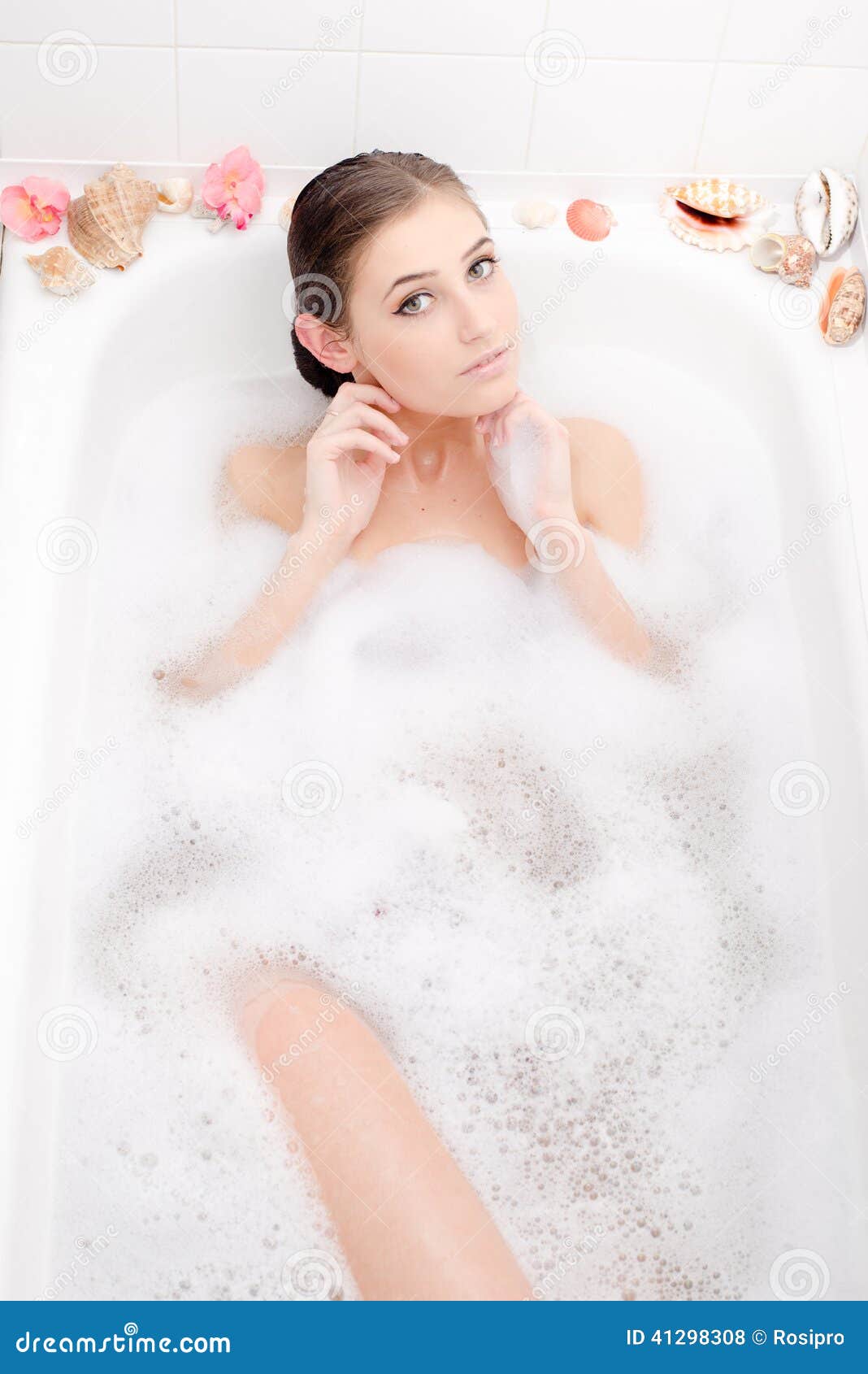 Spa Time Pretty Young Woman Having Fun Lying In A Bathtub With Foam