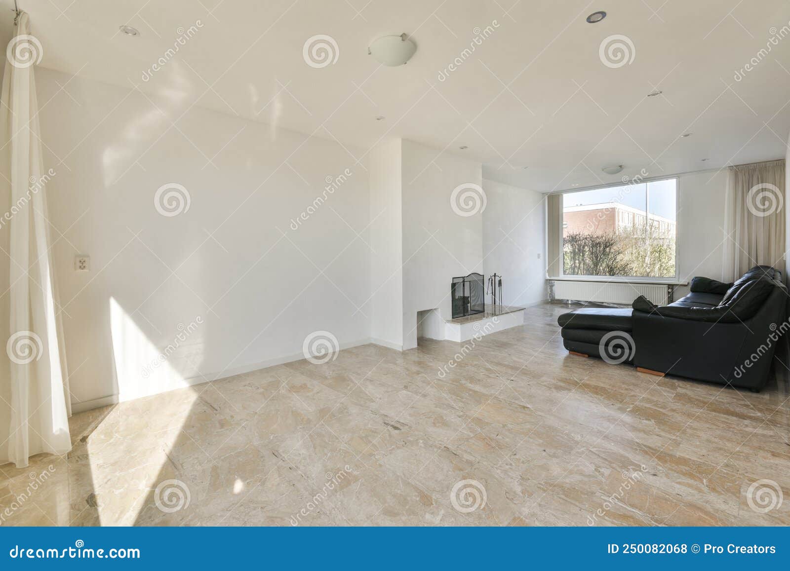 A Spacious Empty Room with a Sofa and Panoramic Windows Stock Photo ...