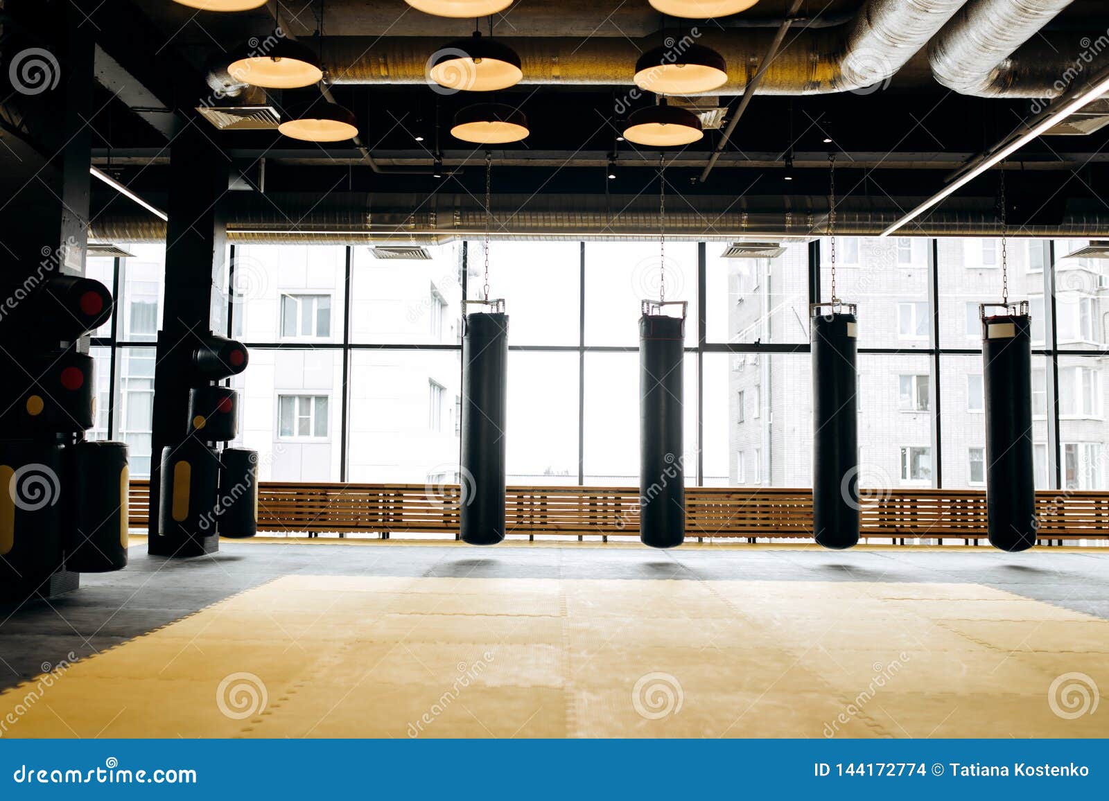 Spacious Gym with Panoramic Windows and Three Punching Bags Stock Photo ...