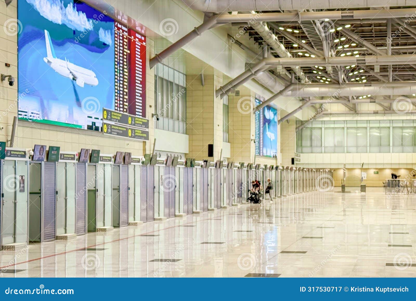 Spacious and Modern Airport Check-in Area Featuring Rows of Counters ...
