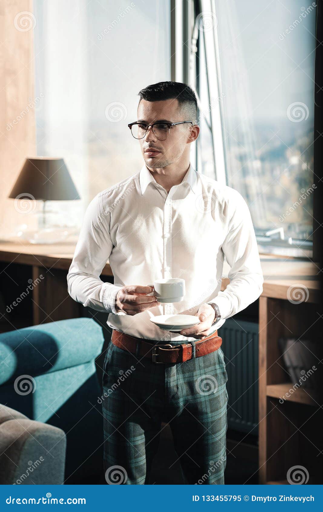 Stylish Young Ceo Standing in His Spacious Light Office Drinking Coffee ...