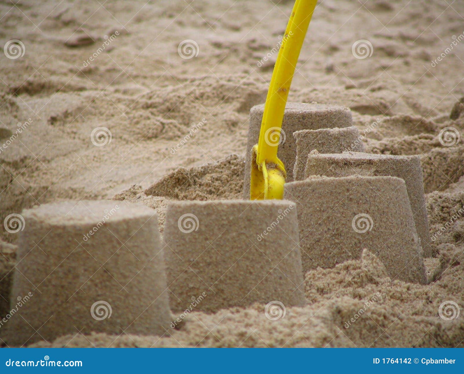 Spade and sand castles stock photo. Image of yellow, coast - 1764142