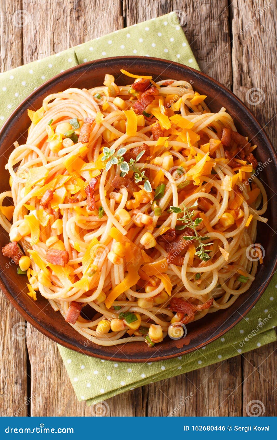Spaghetti with Bacon, Corn and Cheese Mimolette Close-up on a Plate ...