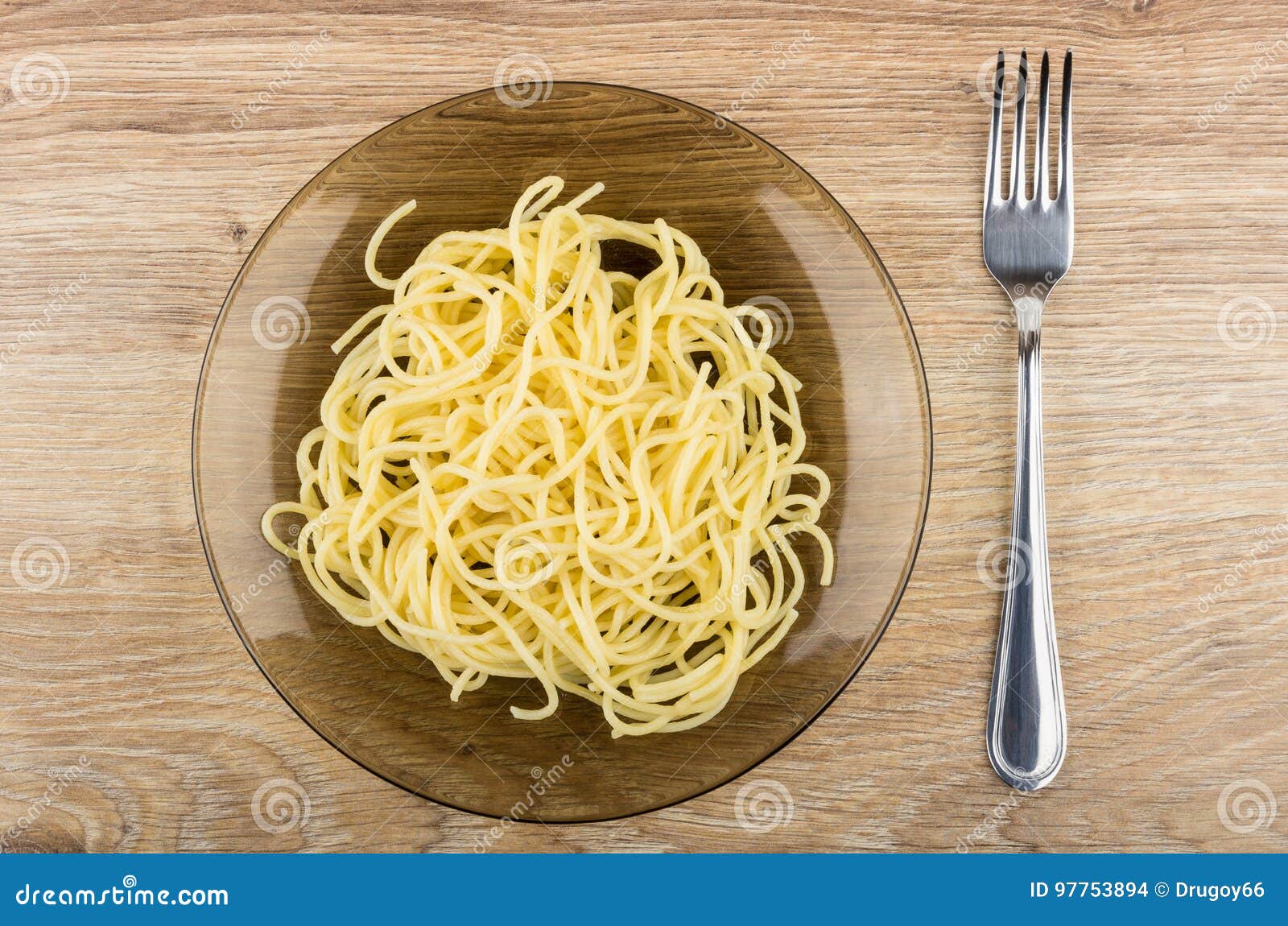Spaghetti in Brown Transparent Plate and Fork on Table Stock Photo ...
