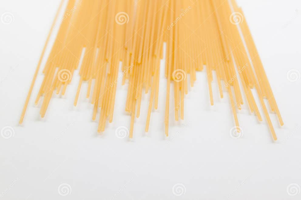 Spaghetti Spread Out on a White Surface Stock Photo - Image of closeup ...