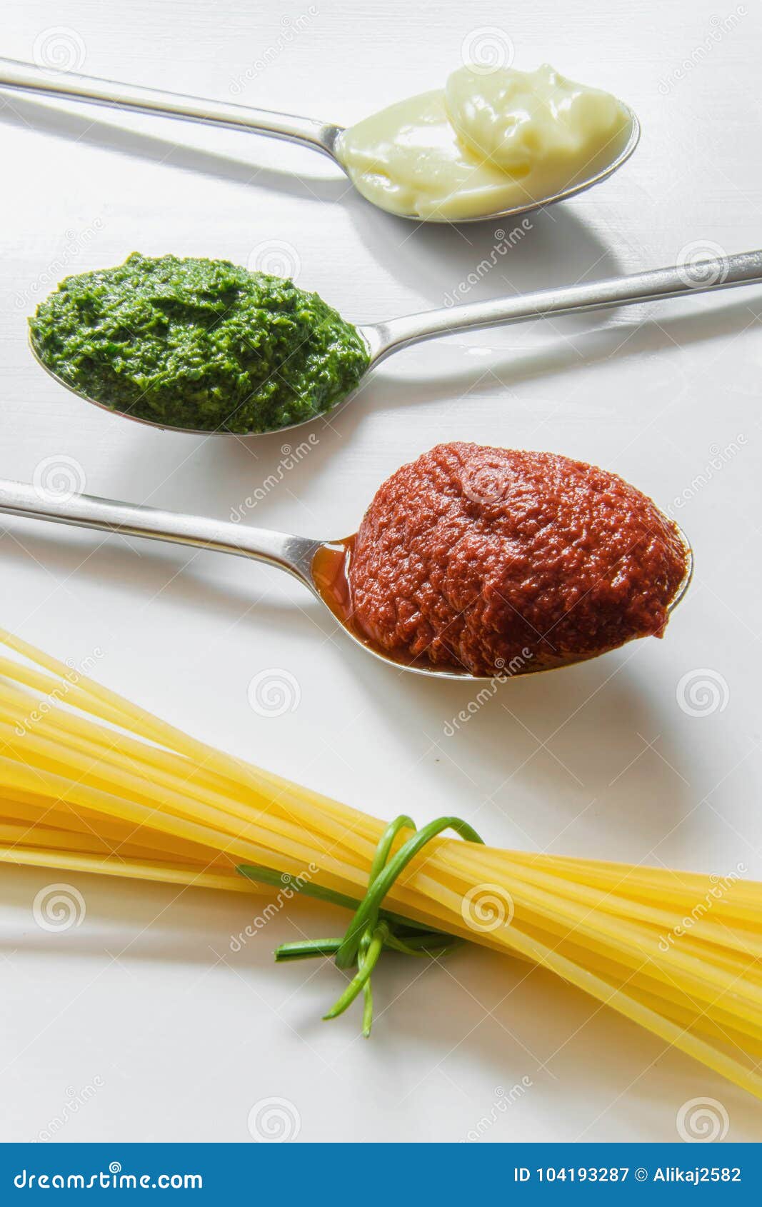 Spaghetti and Three Spoons with Different Condiments Stock Image ...
