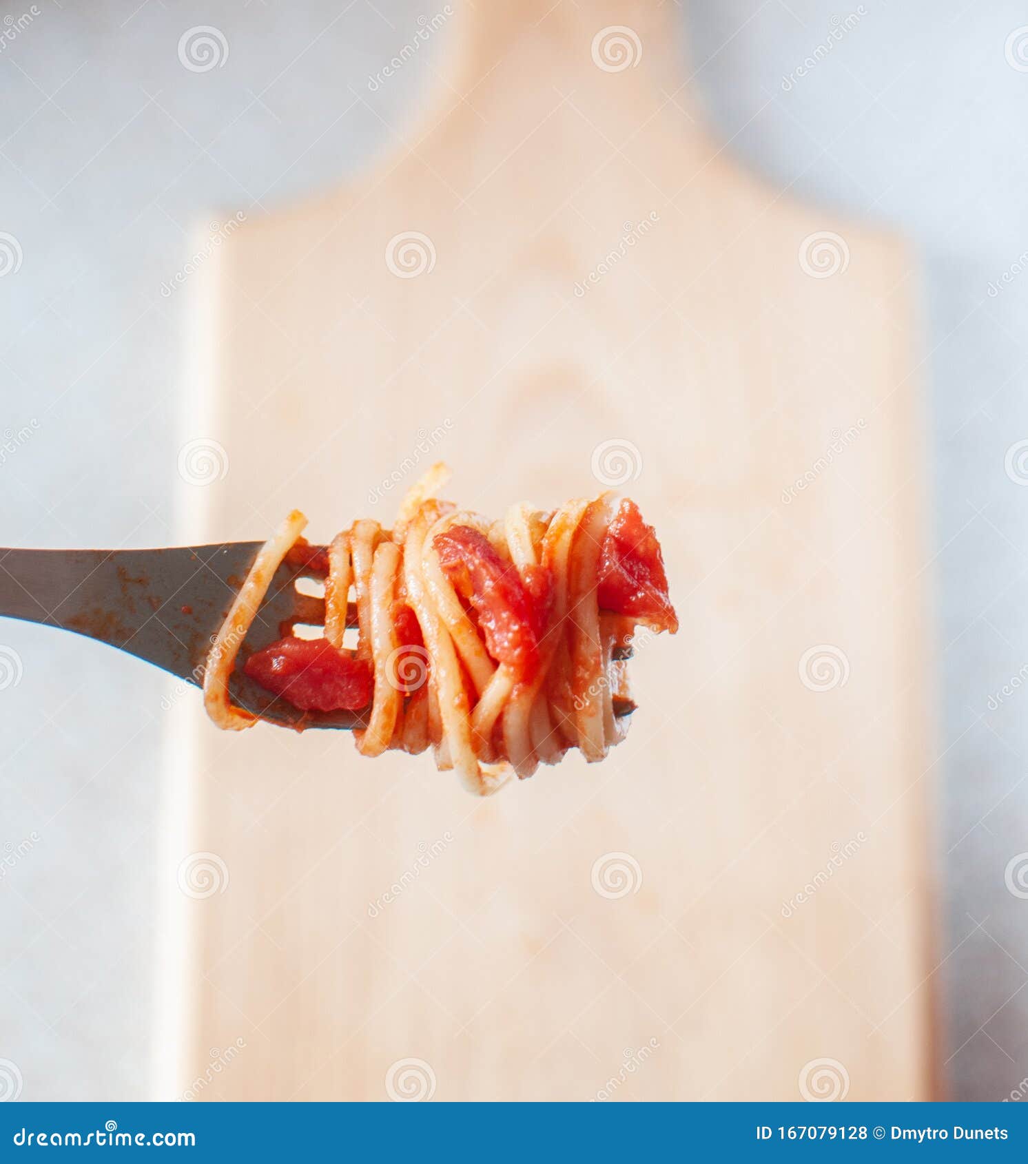 Spaghetti Wound on a Fork with Tomatoes and Basil. Stock Photo - Image ...