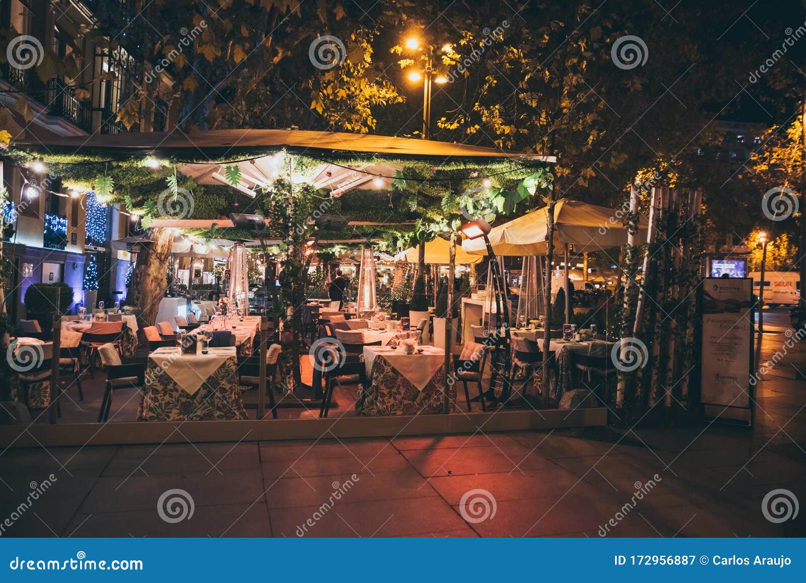 SPAIN - DECEMBER 12: Illuminated Restaurant with Tables Outside ...