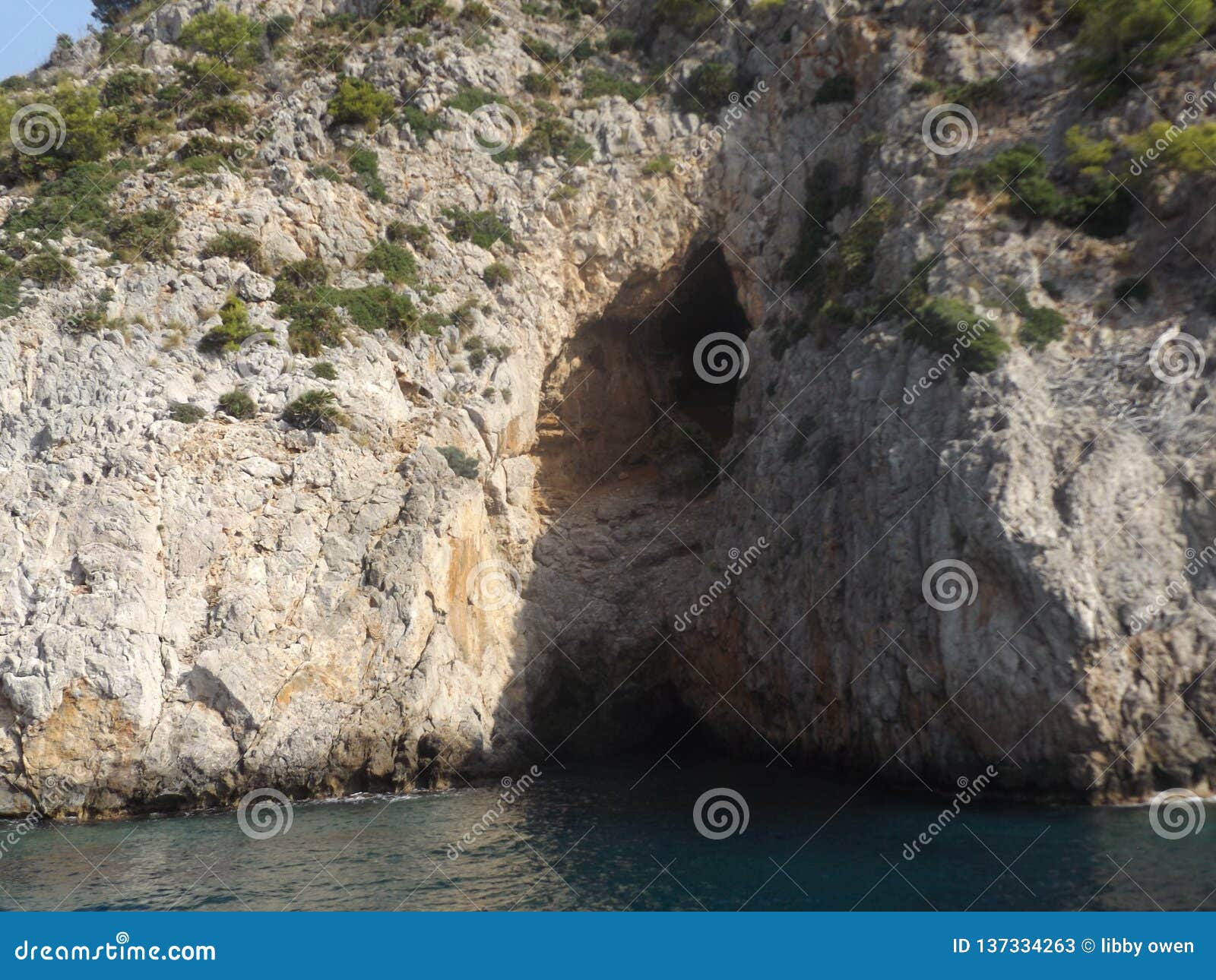 Cliff cave stock image. Image of cave, green, cliff - 137334263