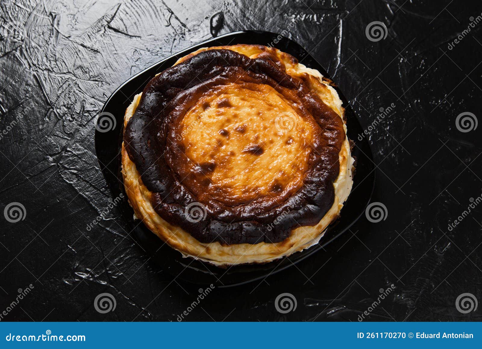 Spanish Basque Cheesecake on Black Glass Plate, on Black Slate Stock ...