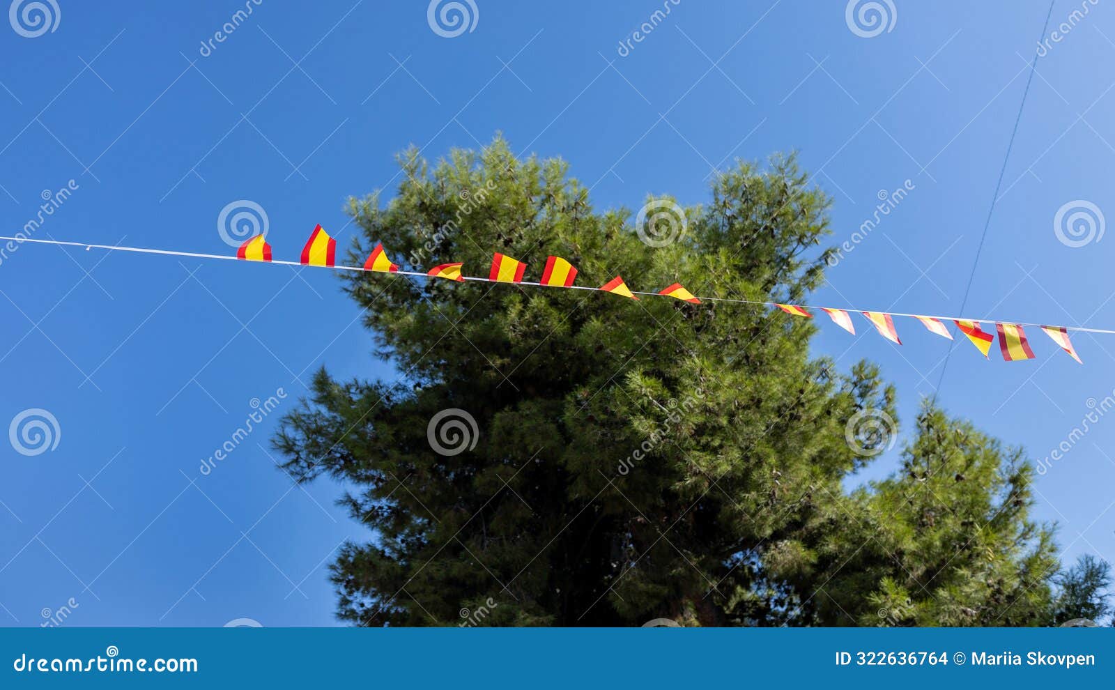 Spanish Flags Flap Under the Gusts of Wind on the Background of Blue ...