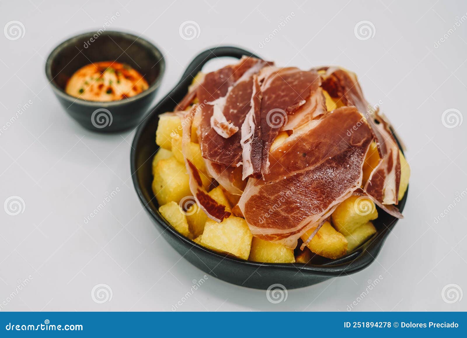 Spanish Patatas Bravas Ration with Iberian Cured Ham Stock Photo ...