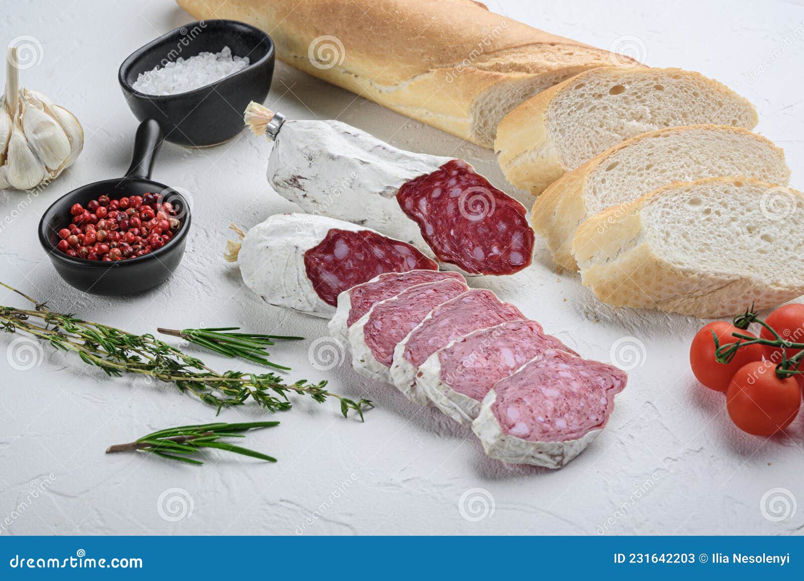 Spanish Salcichon Slices with Panini and Herbs on White Surface Stock ...