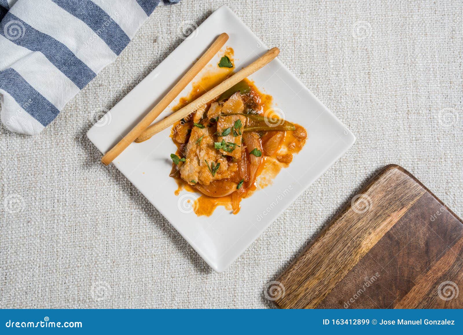 Spanish Tapa of Fish with Orange Sauce and Bread Sticks Stock Image ...