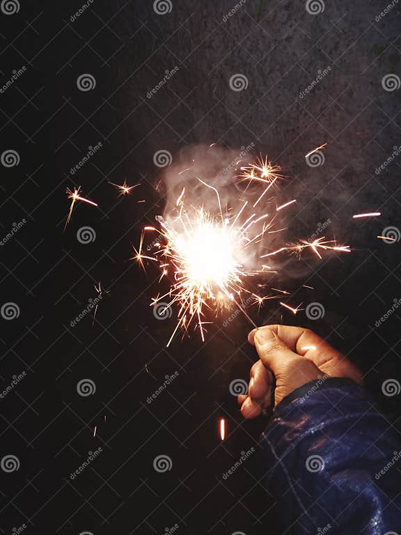 A Spark Crackers in Manâ€™s Hand Stock Photo - Image of light, crackers ...