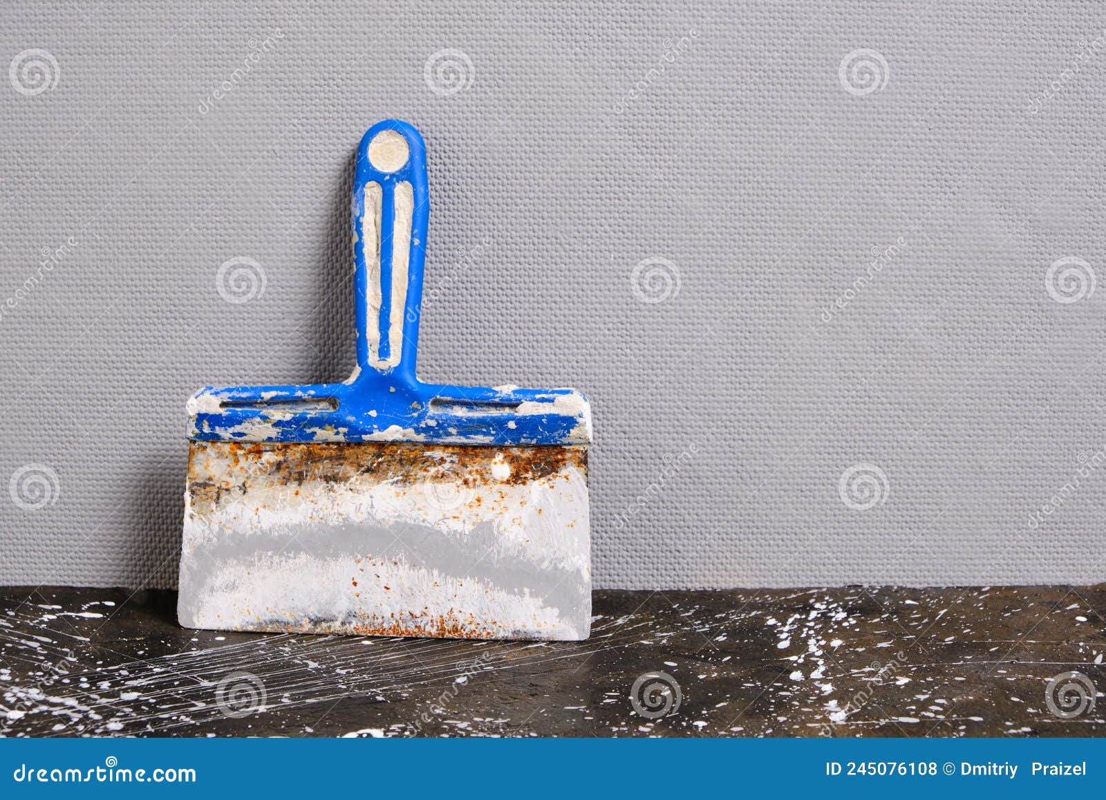 Spatula for Finishing and Plastering Walls on a Gray Wall Background ...