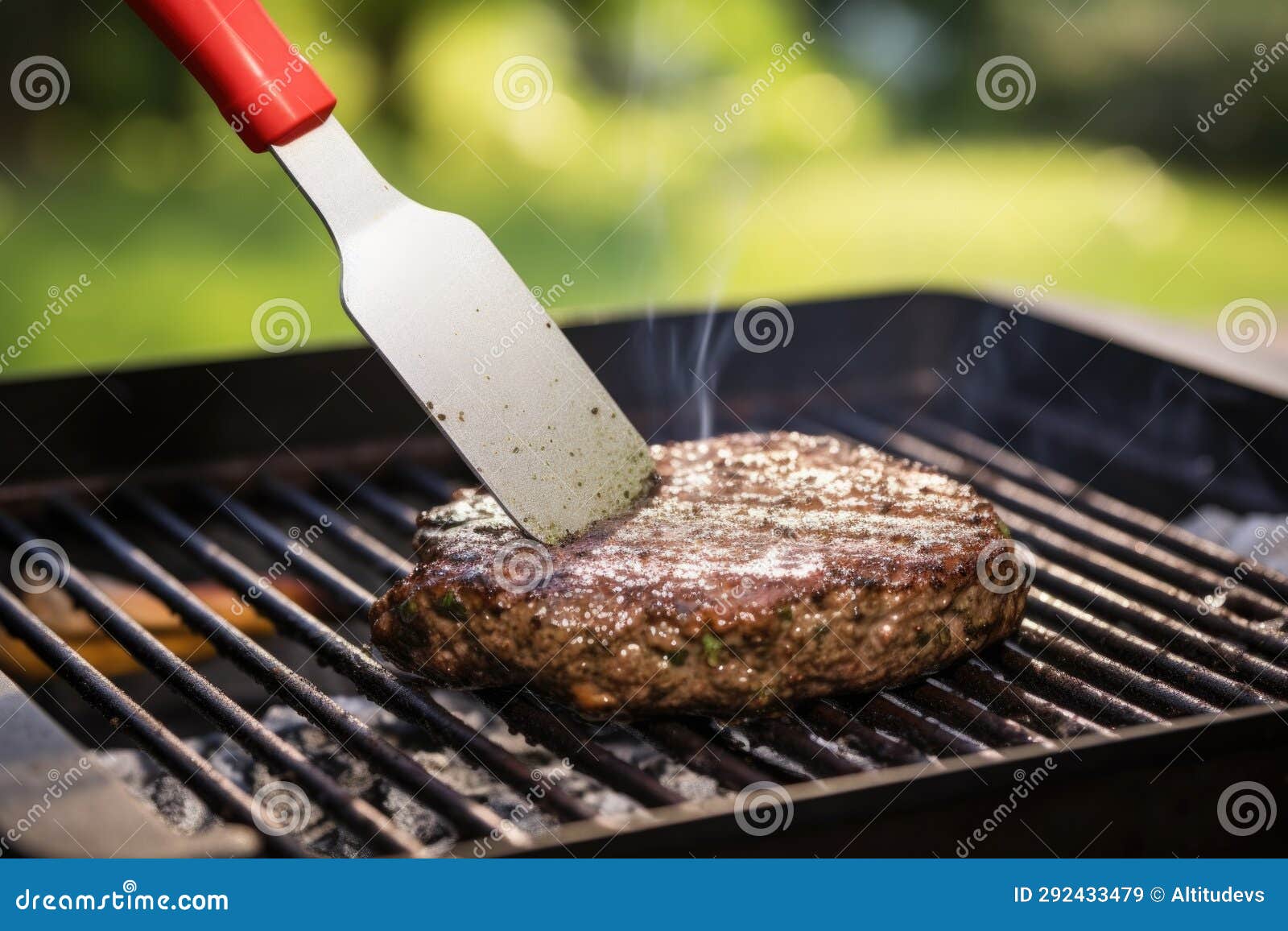 Spatula Flipping an Oversized Burger Patty on a Grilling Pan Stock ...