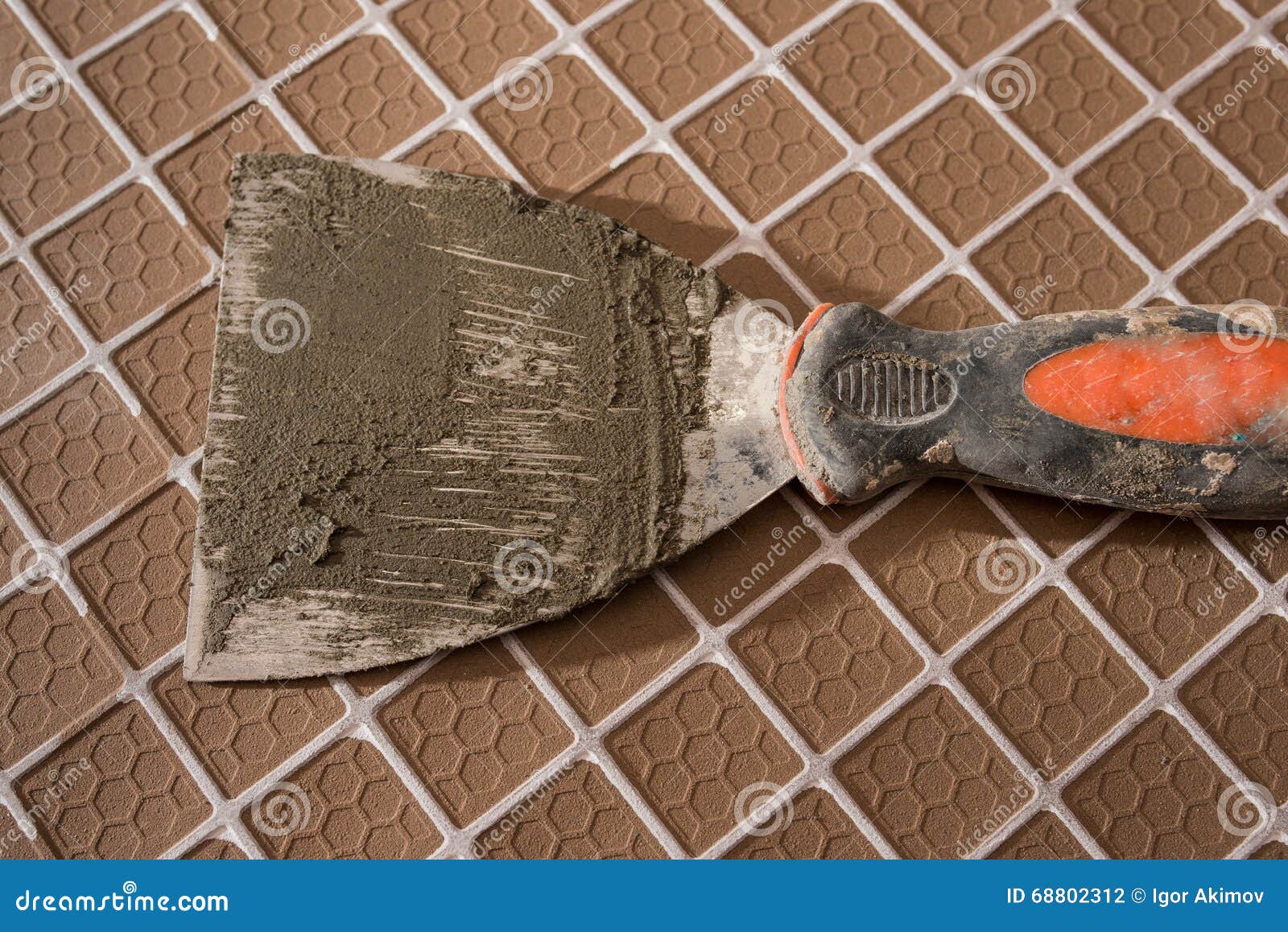 Spatula for laying tiles stock photo. Image of architecture - 68802312