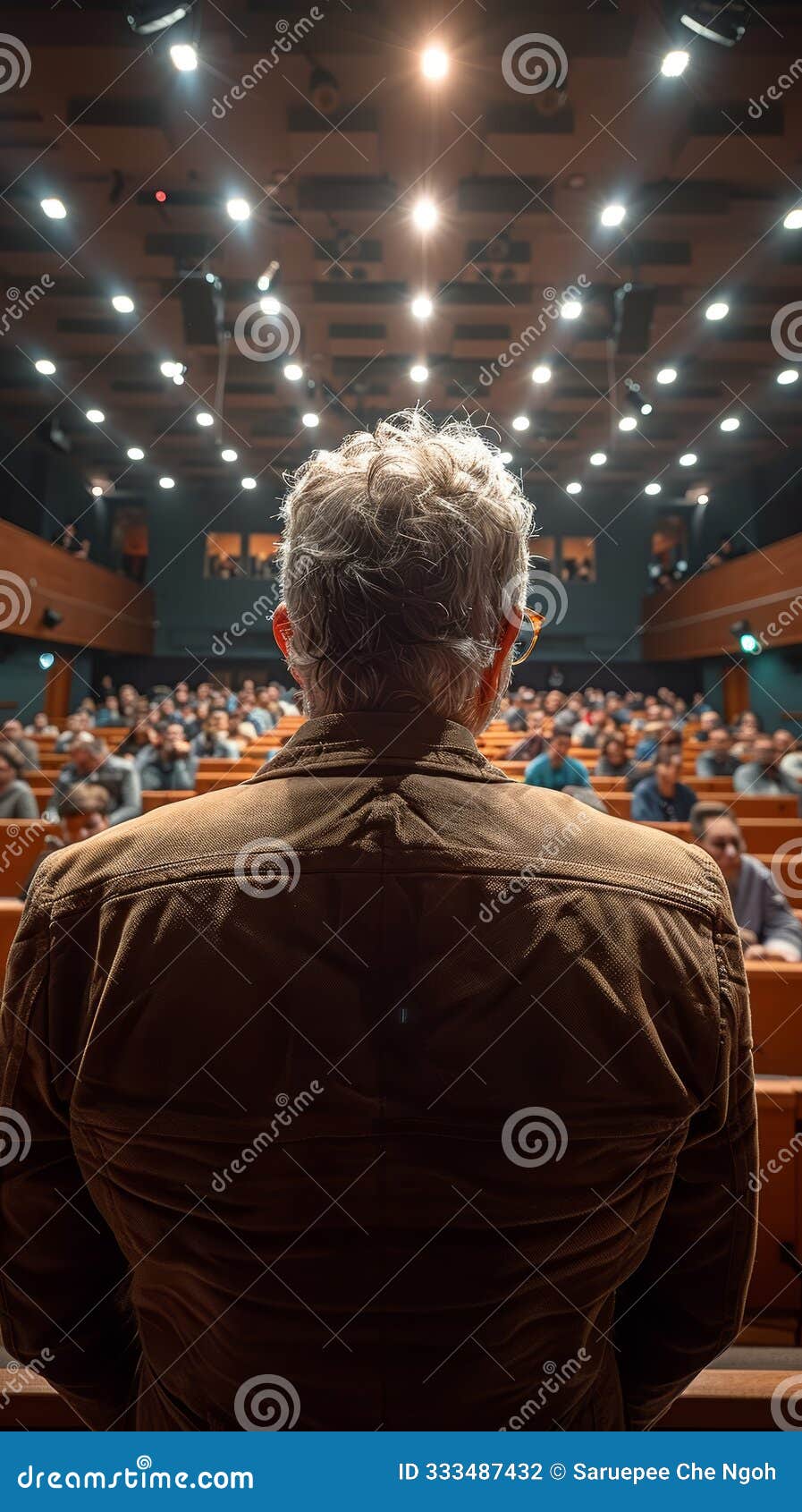 Speaker Addressing Audience in Modern Lecture Hall with Bright Lighting ...