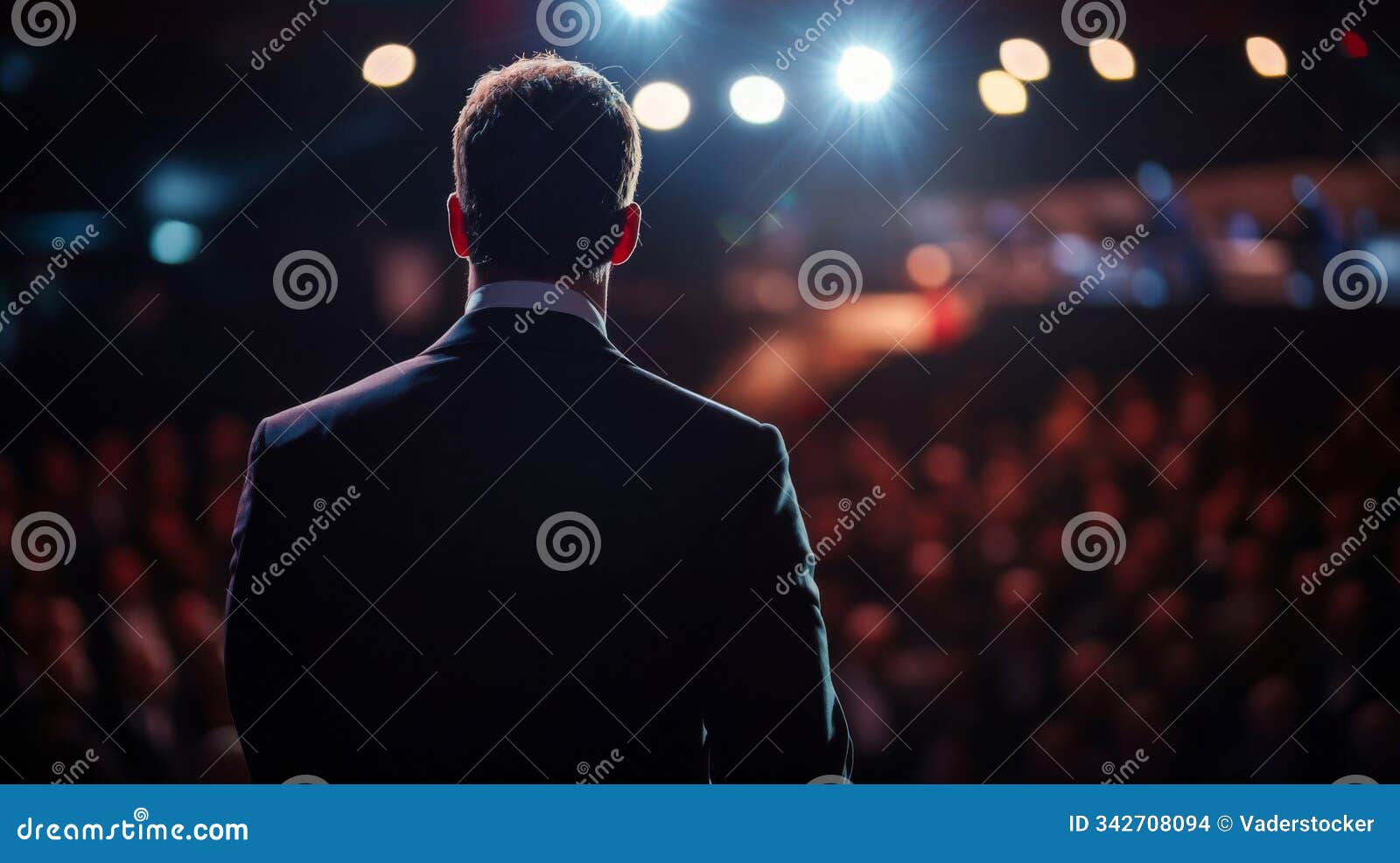 A Speaker Facing an Audience, Back Lit by Stage Lights Stock ...