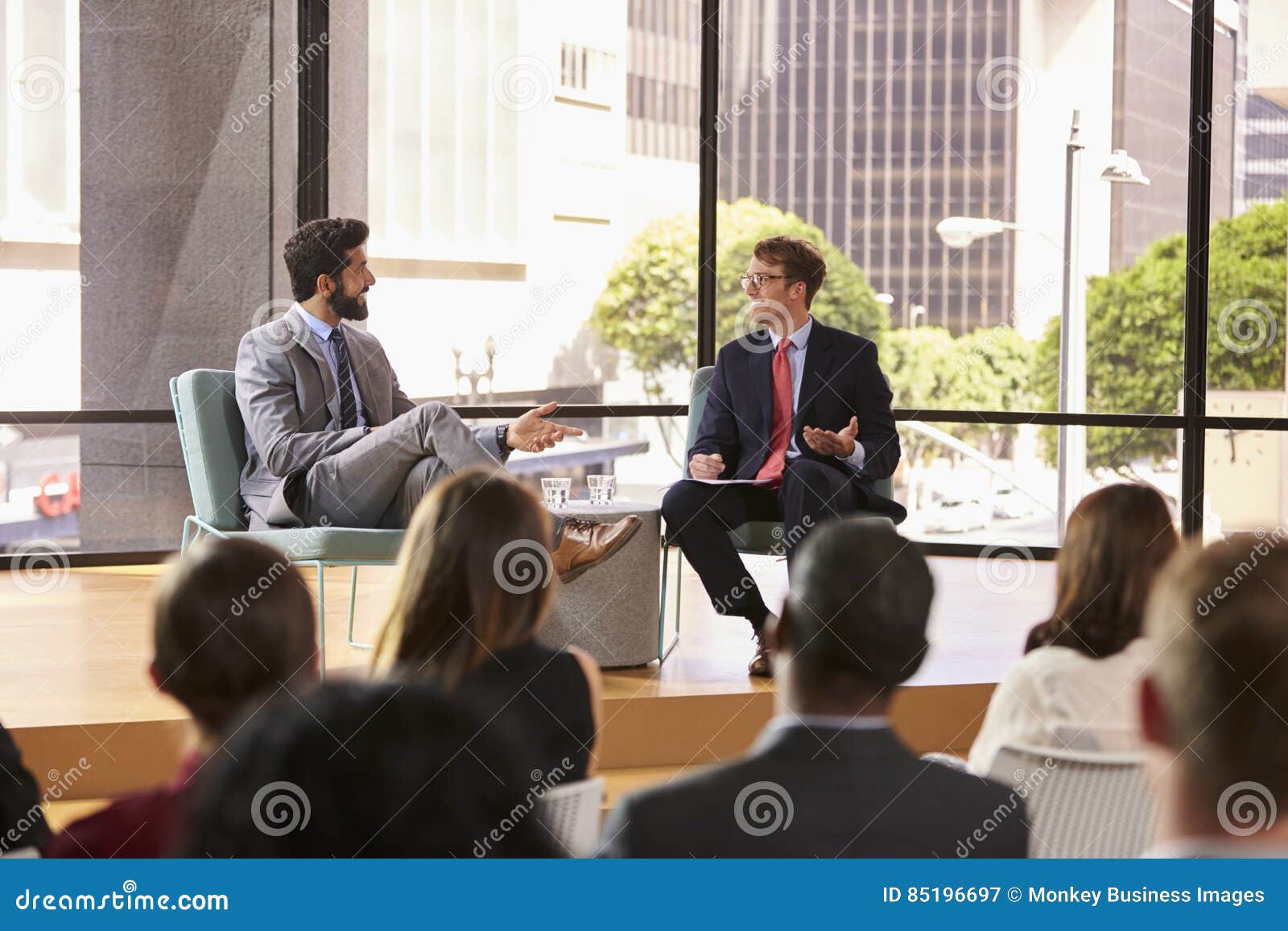 Speaker and Interviewer Talk in Front of Audience at Seminar Stock ...