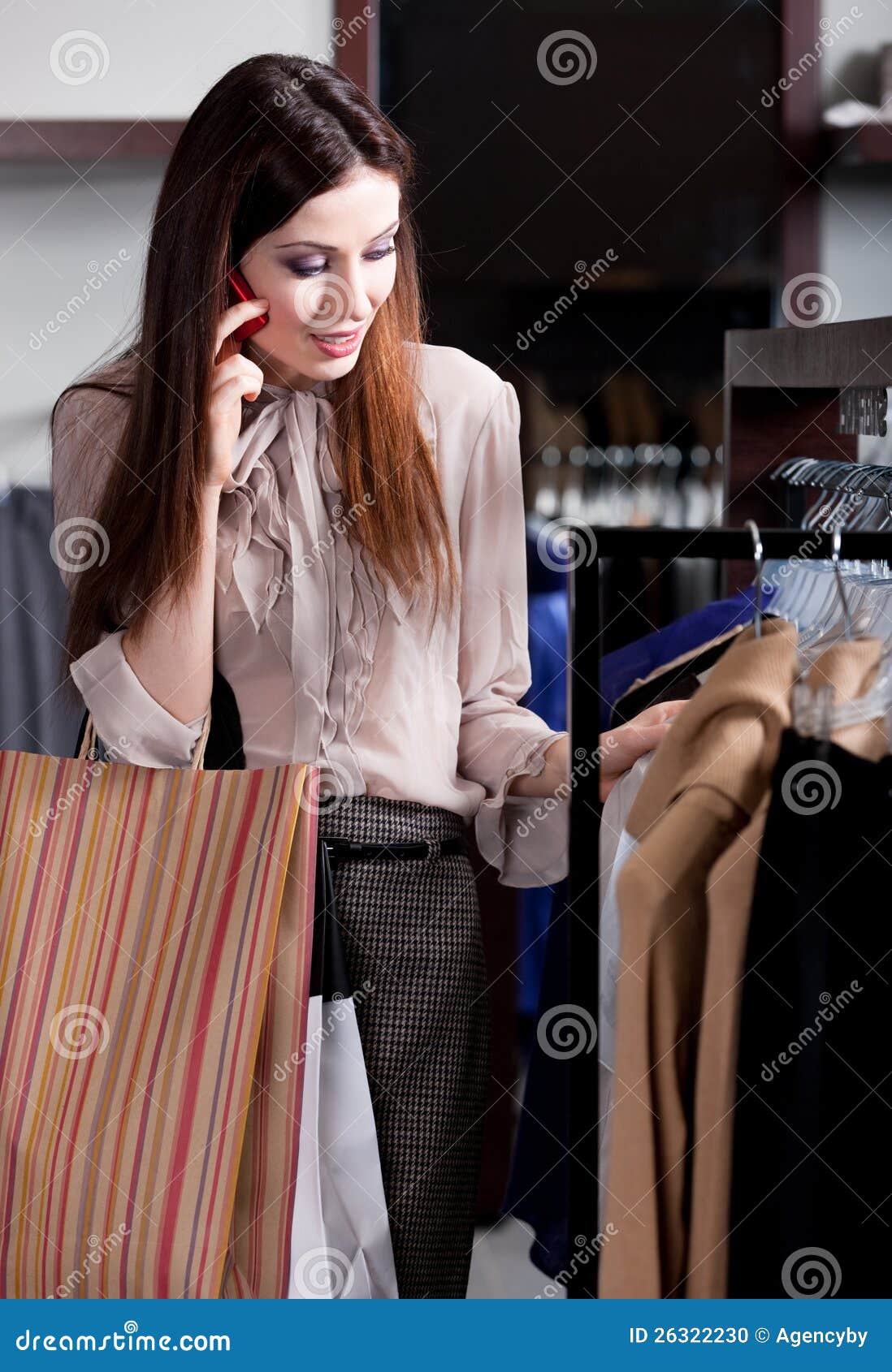 Speaking on the Cellphone and Choosing Clothes Stock Photo - Image of ...