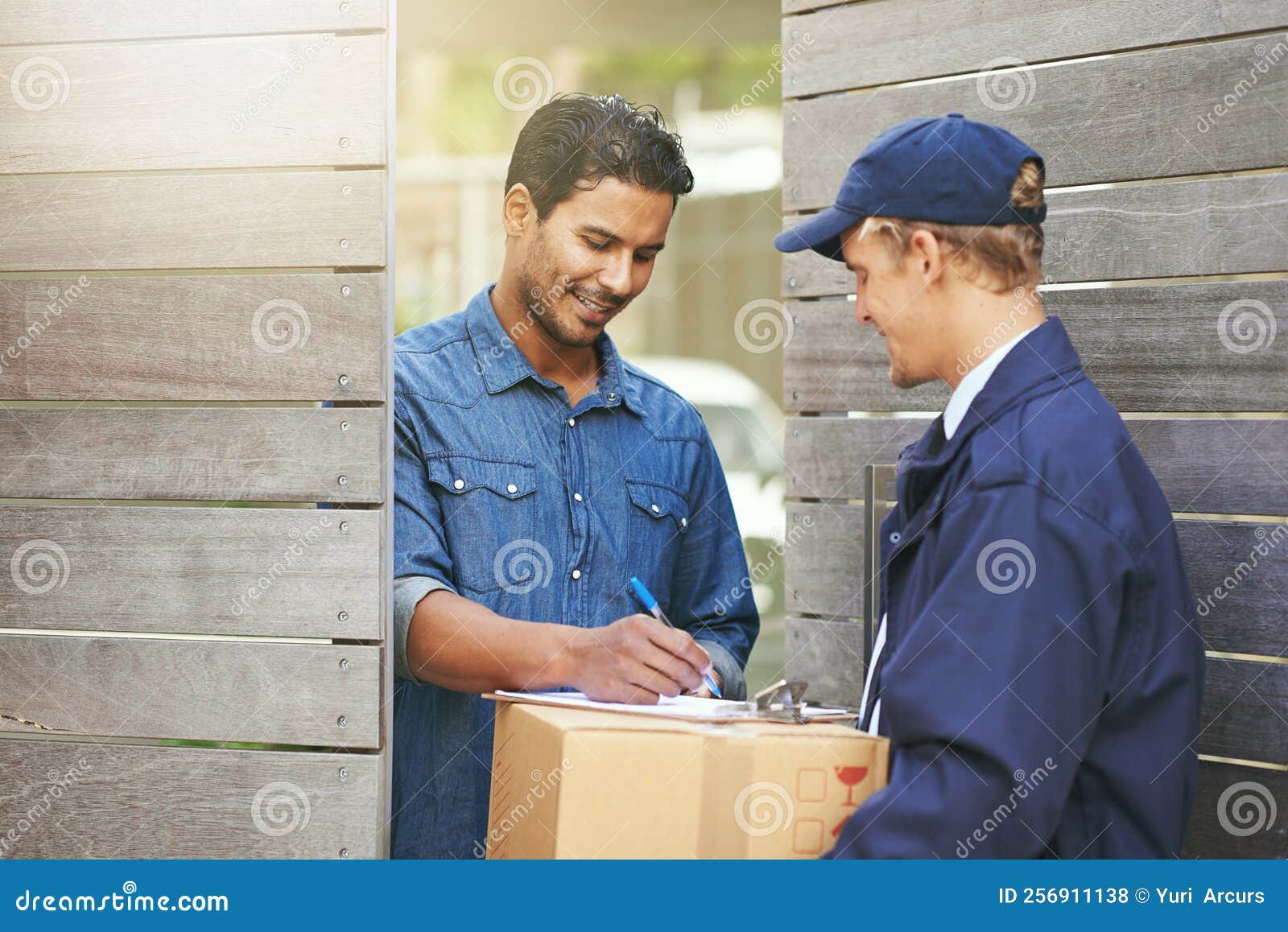 Special Delivery. a Young Man Receiving a Package at Home. Stock Photo ...