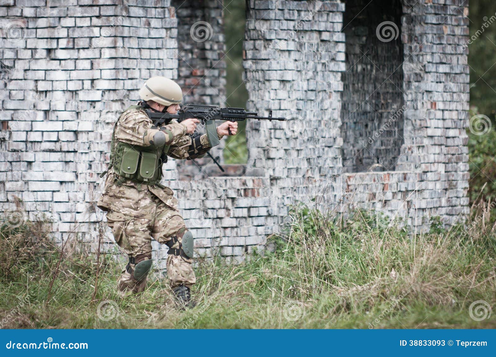 Soldier With An Assault Rifle Wearing A Tactical Load-carrying Vest ...
