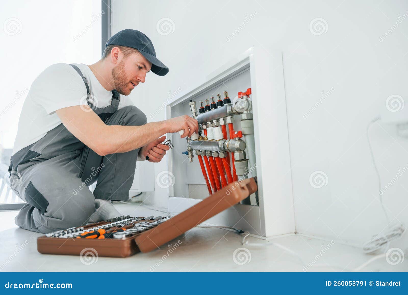 With Special Tools. Repairman is Working Indoors in the Modern Room ...