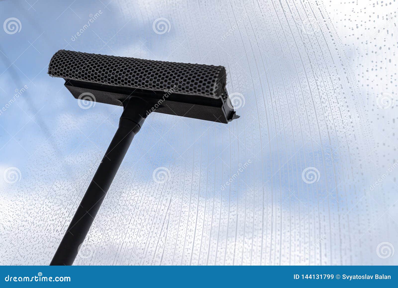 A Special Window Cleaner Cleans the Foamy Liquid from the Glass Surface ...