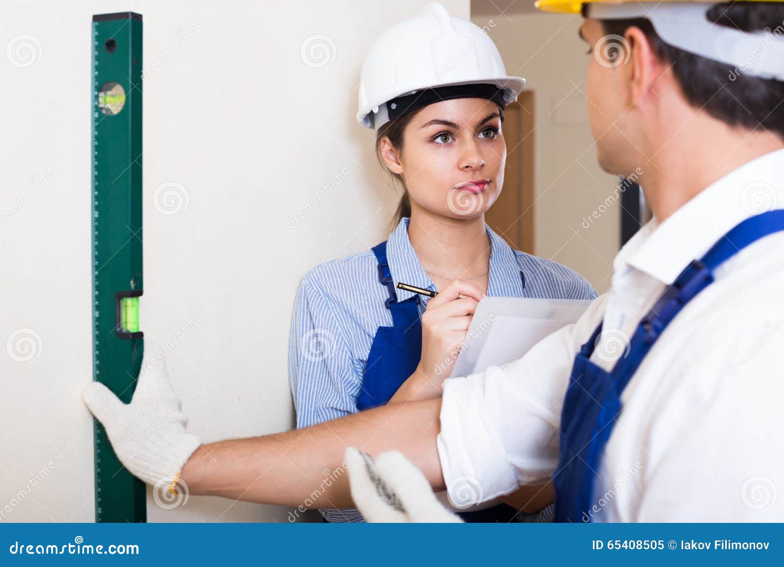 Specialist and Assistant Working with Wall in New Building Stock Image ...