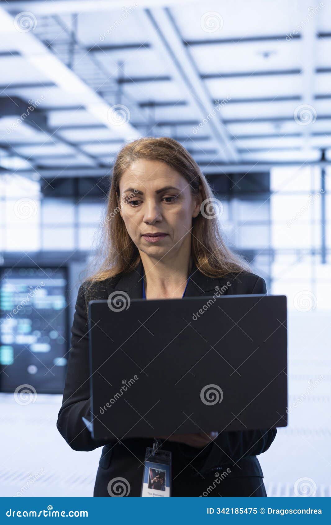 It Specialist in Data Center Holding Notebook, Replacing Mainframes ...