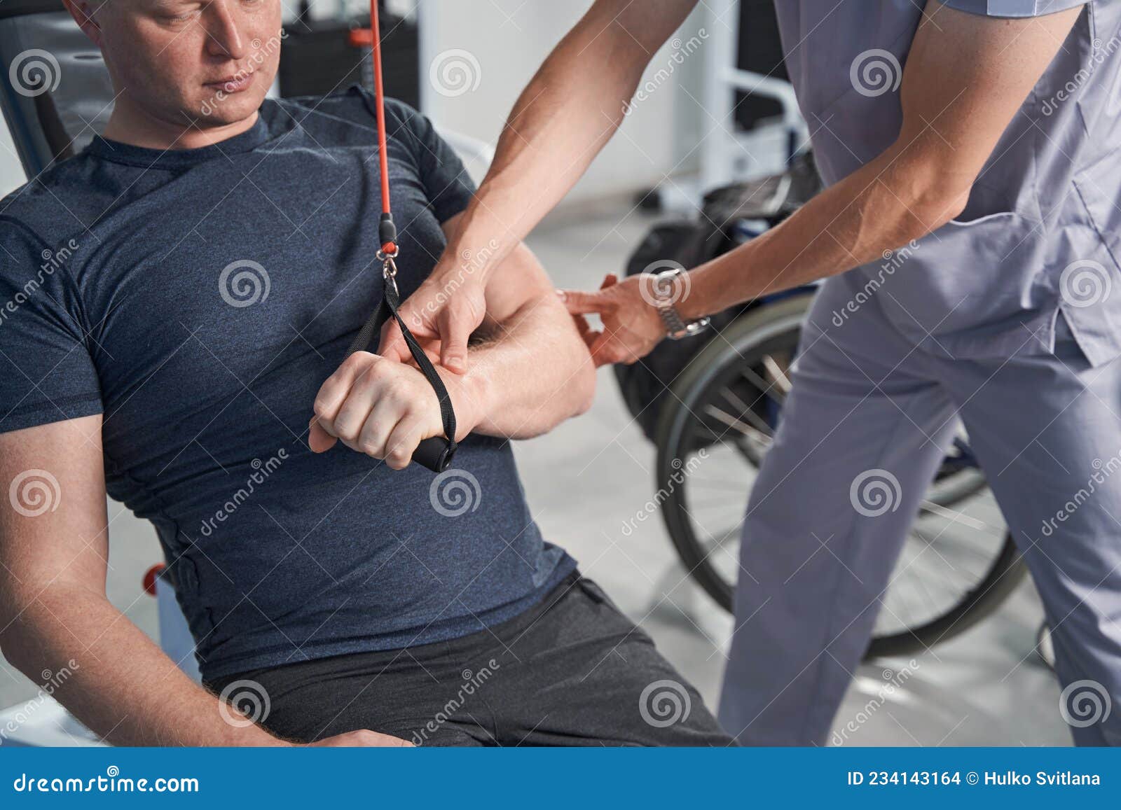 Specialist Helps Man with Disability Pull Weight on Lifting Machine ...