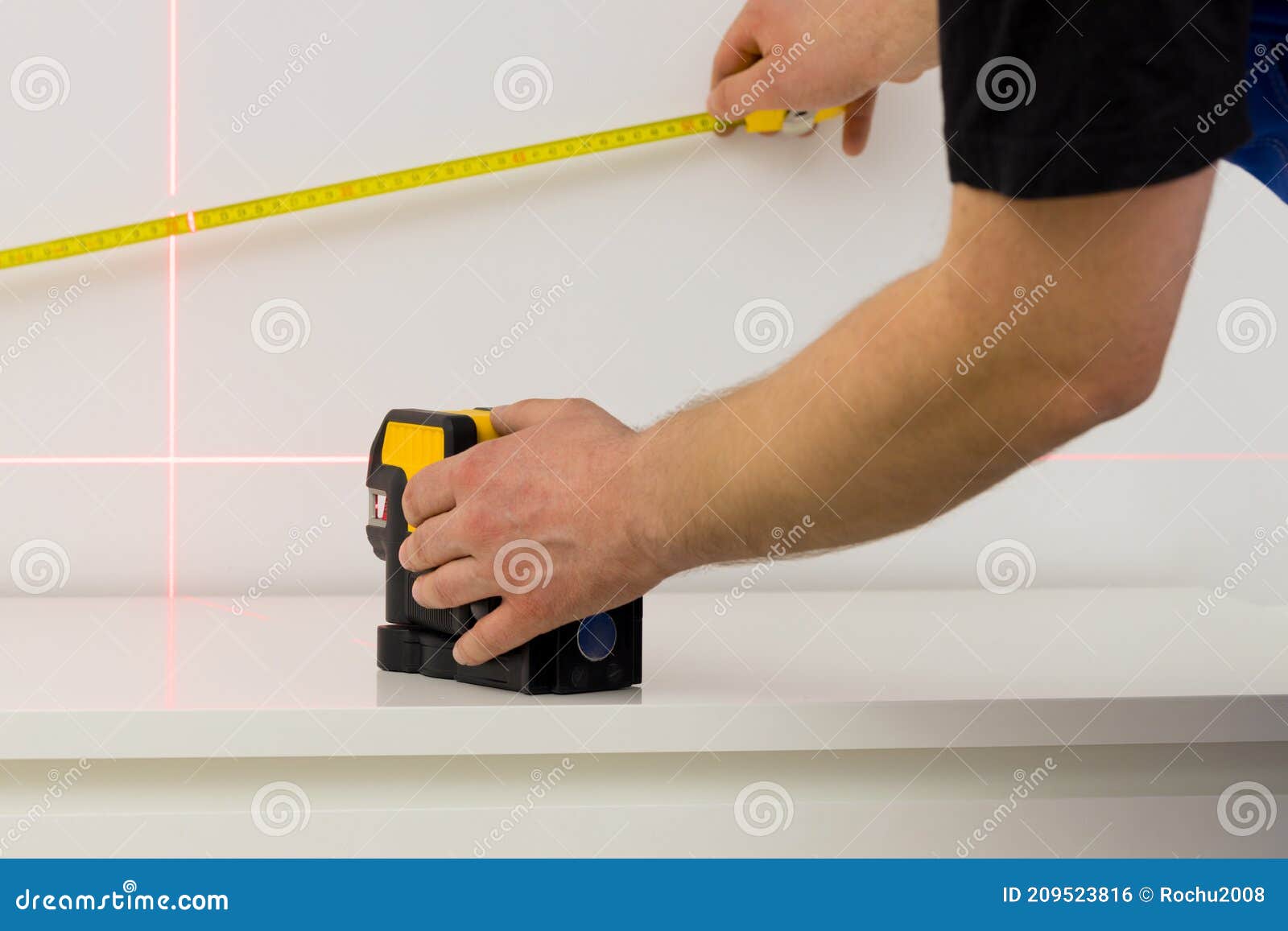 A Specialist Makes Measurements Using an Electronic Laser Measuring the ...