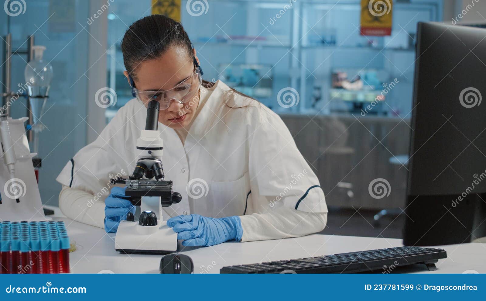 Specialist with Safety Goggles Using Microscope in Laboratory Stock ...
