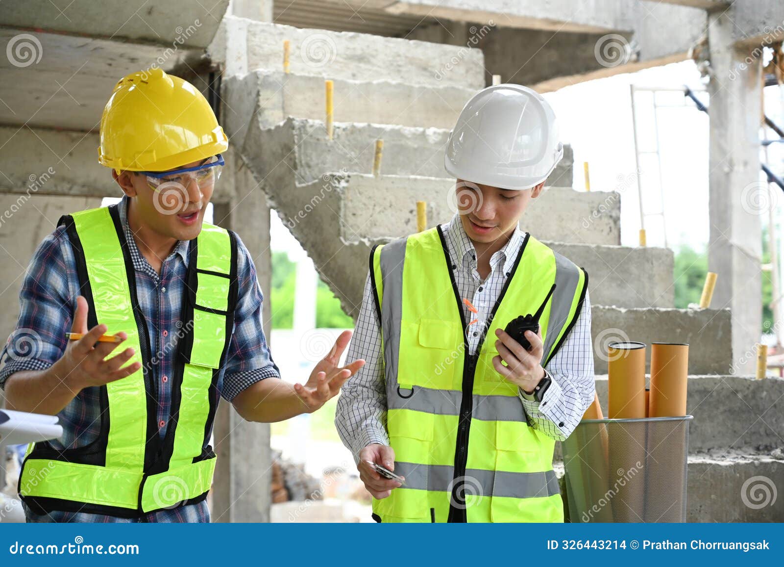 Specialists Team in Safety Vest and Helmet Discussing Structure of the ...