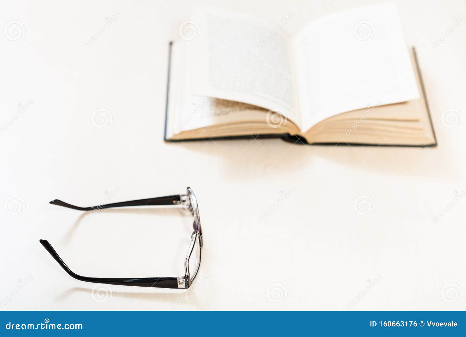 Spectacles and Open Book on Pale Table Stock Photo - Image of glasses ...